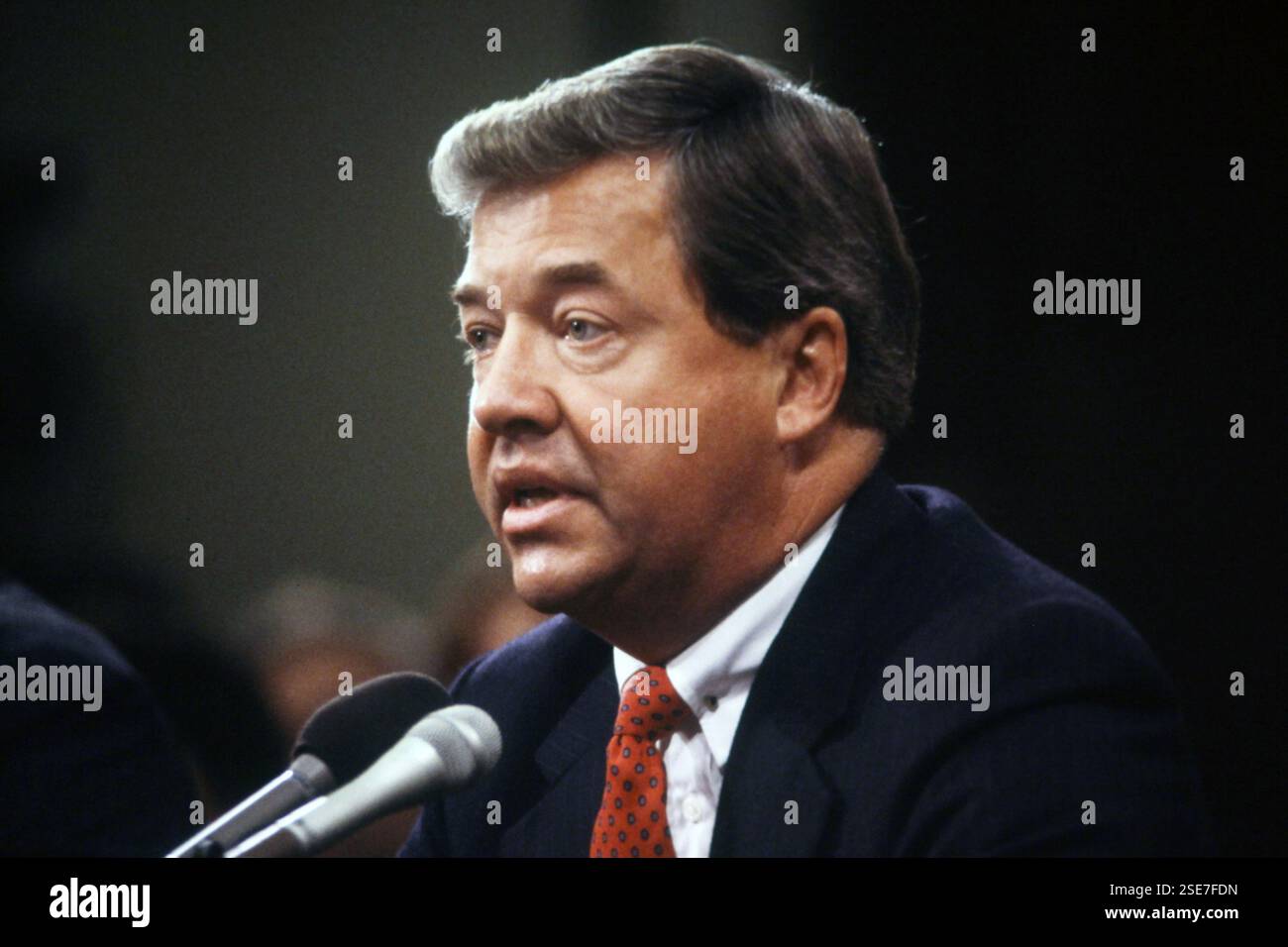 Robert Dutton testifies at an Iranscam hearing Photograph by Dennis ...