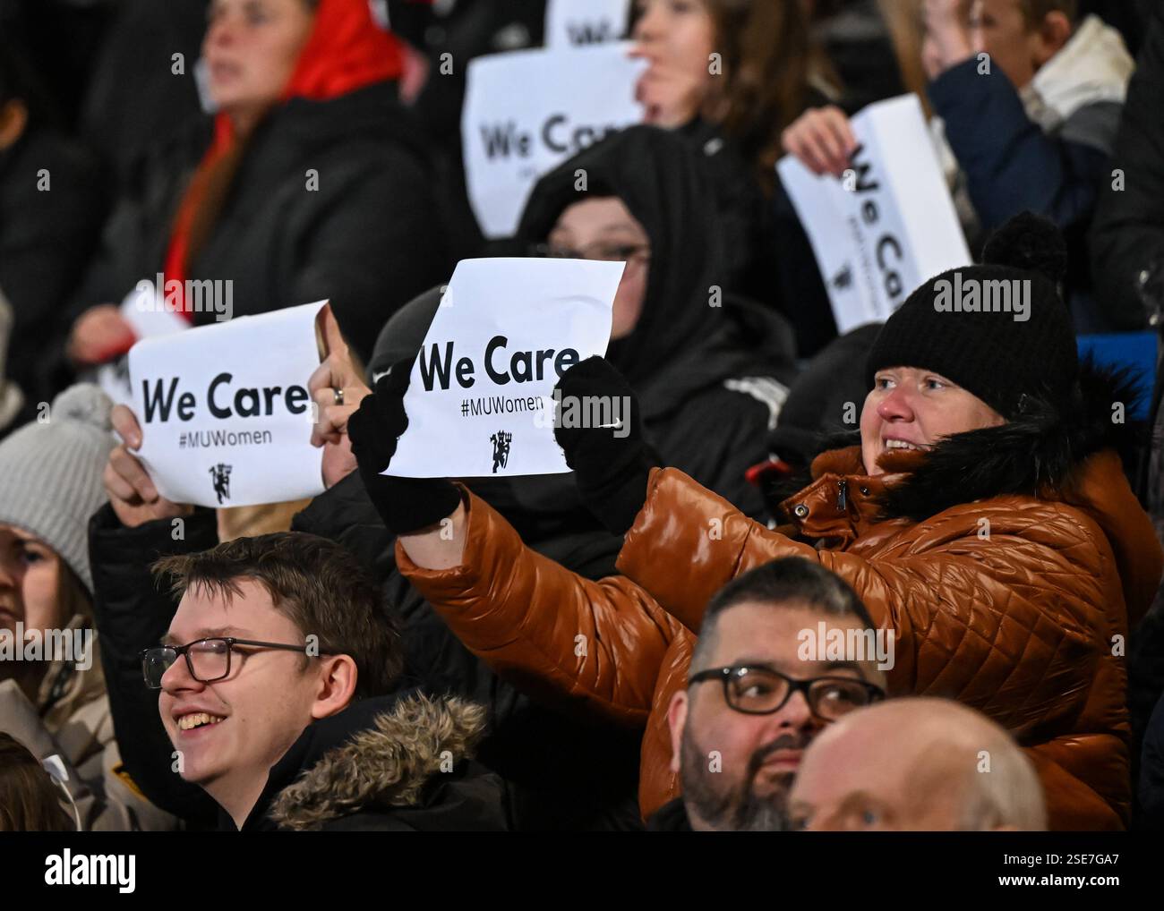 Manchester United fans hold up ???we care??? signs ahead of the Adobe ...