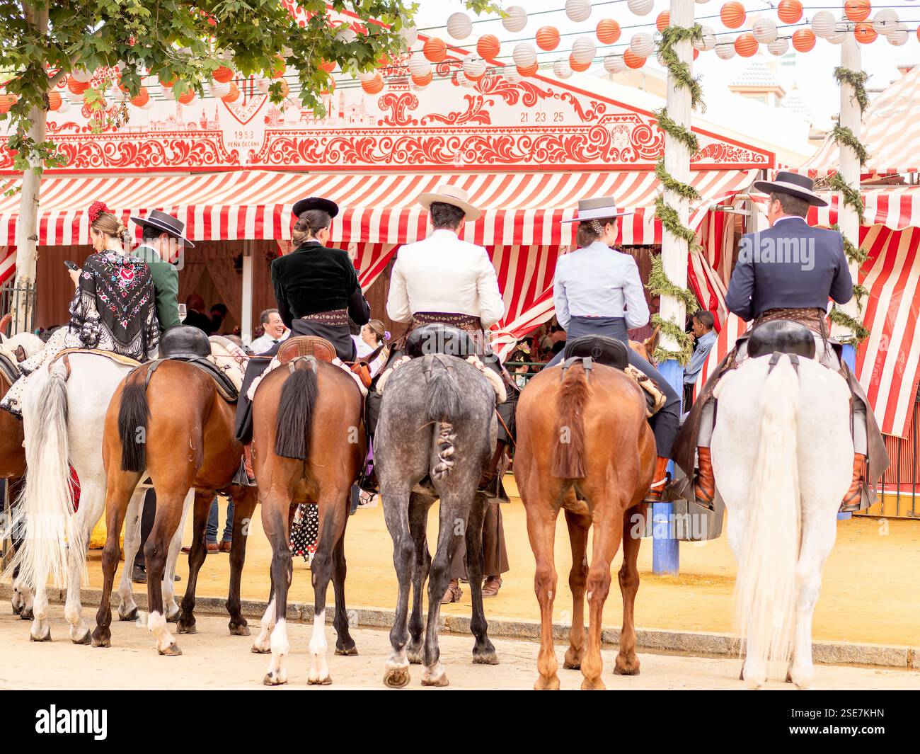 Group of Spanish riders in traditional attire on horseback at an ...