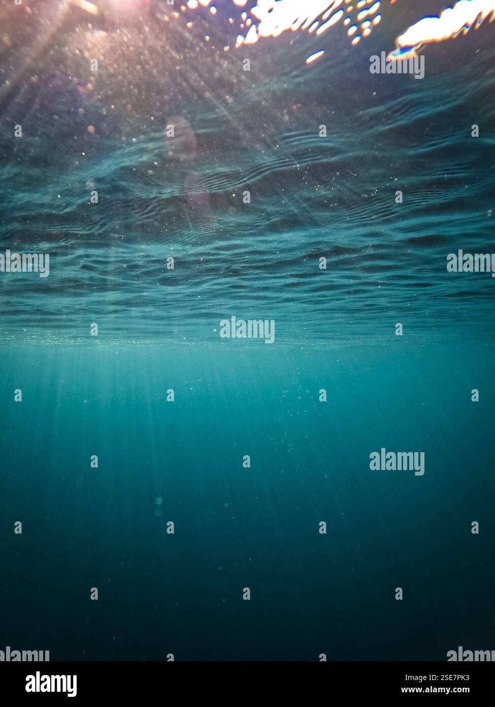 Deep blue underwater background with sunrays and reflections on the ...