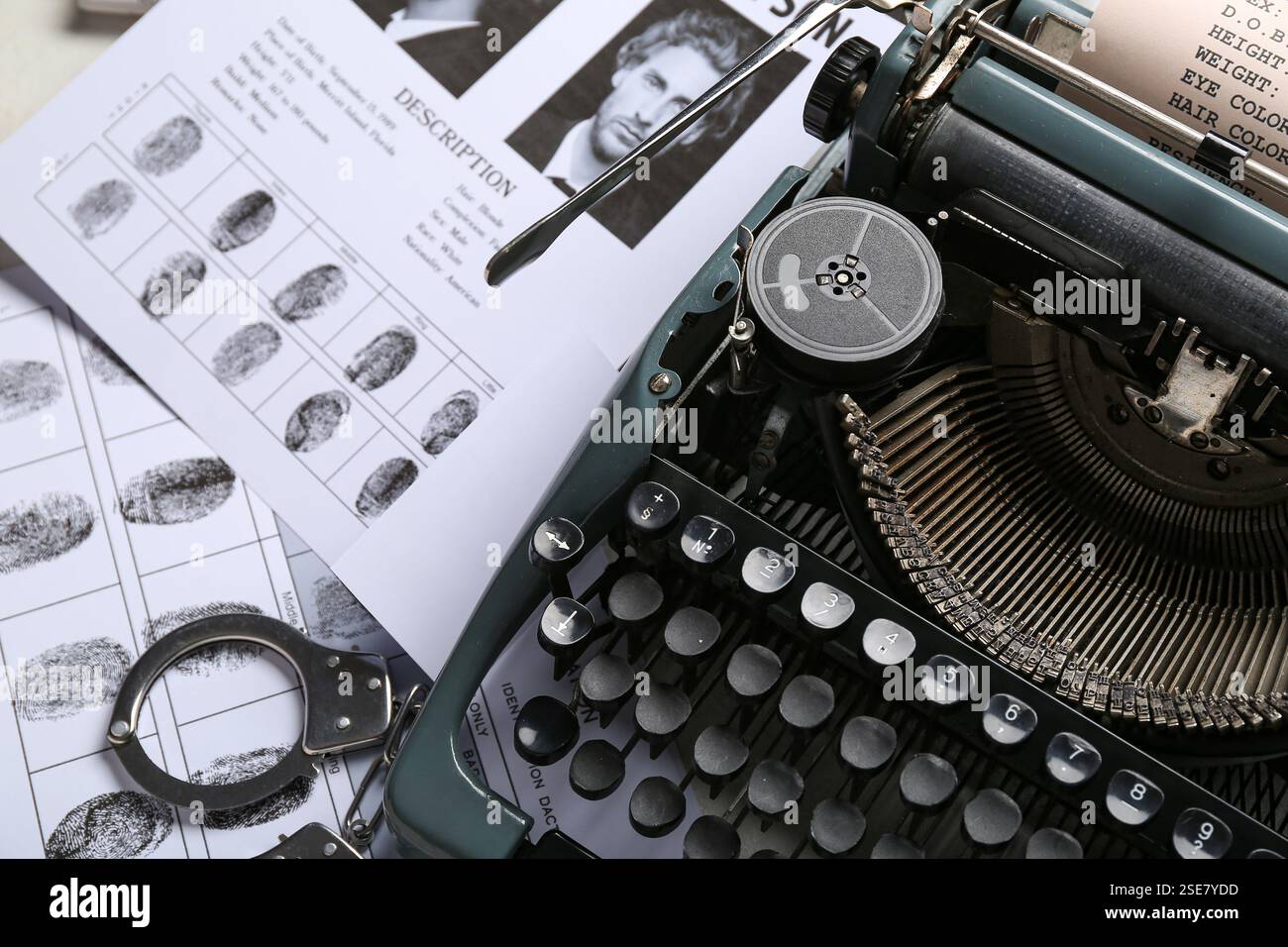 Retro typewriter, handcuffs, wanted poster and fingerprints, closeup ...