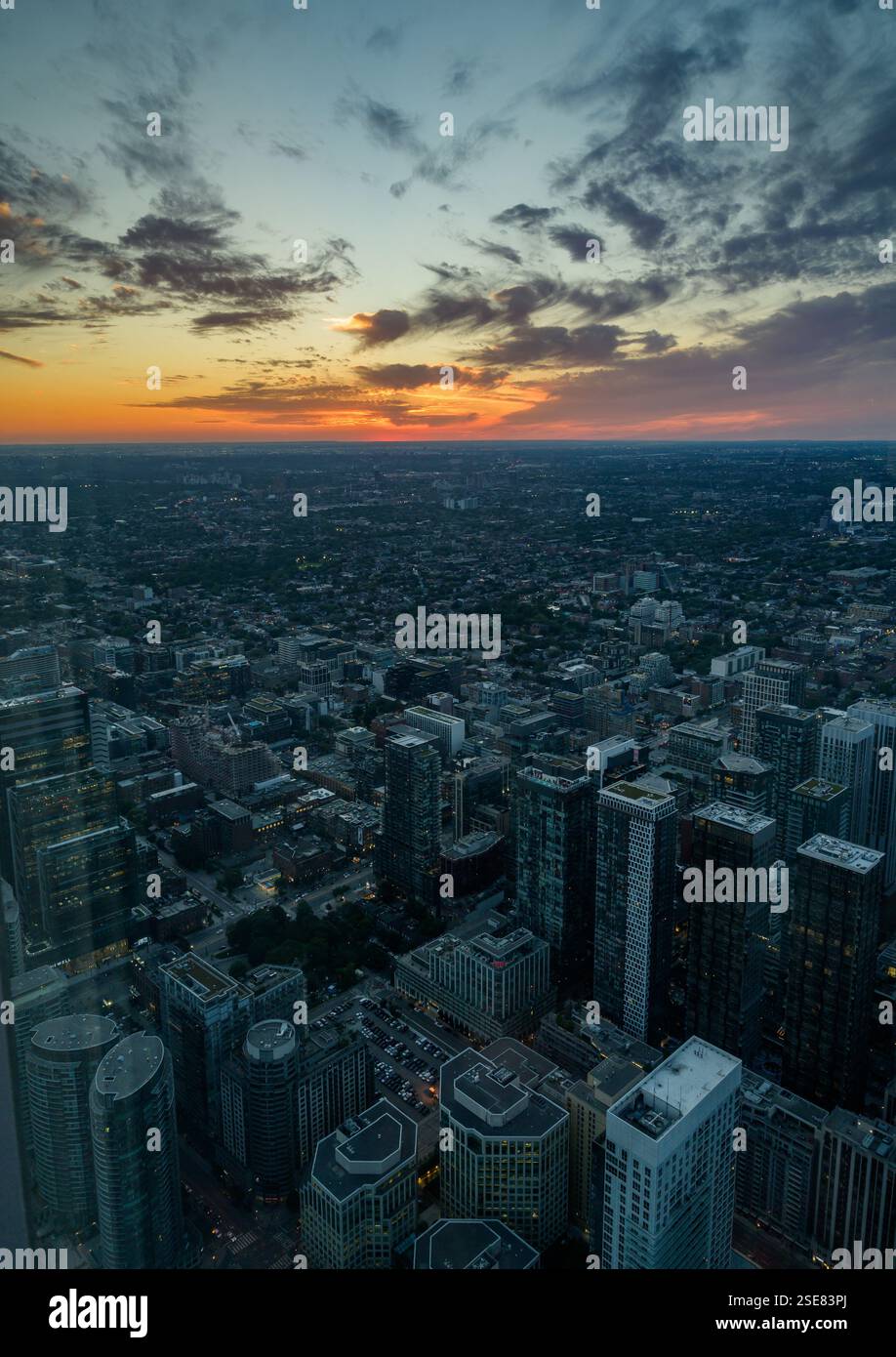 A breathtaking sunset casts vibrant hues over a bustling city skyline ...