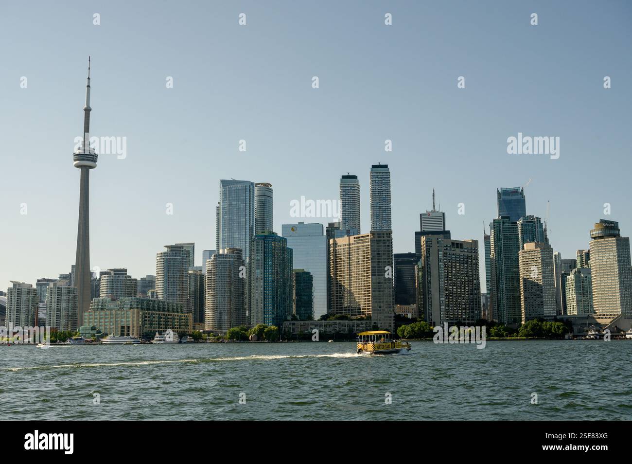 A vibrant city skyline showcases modern skyscrapers beside a body of ...