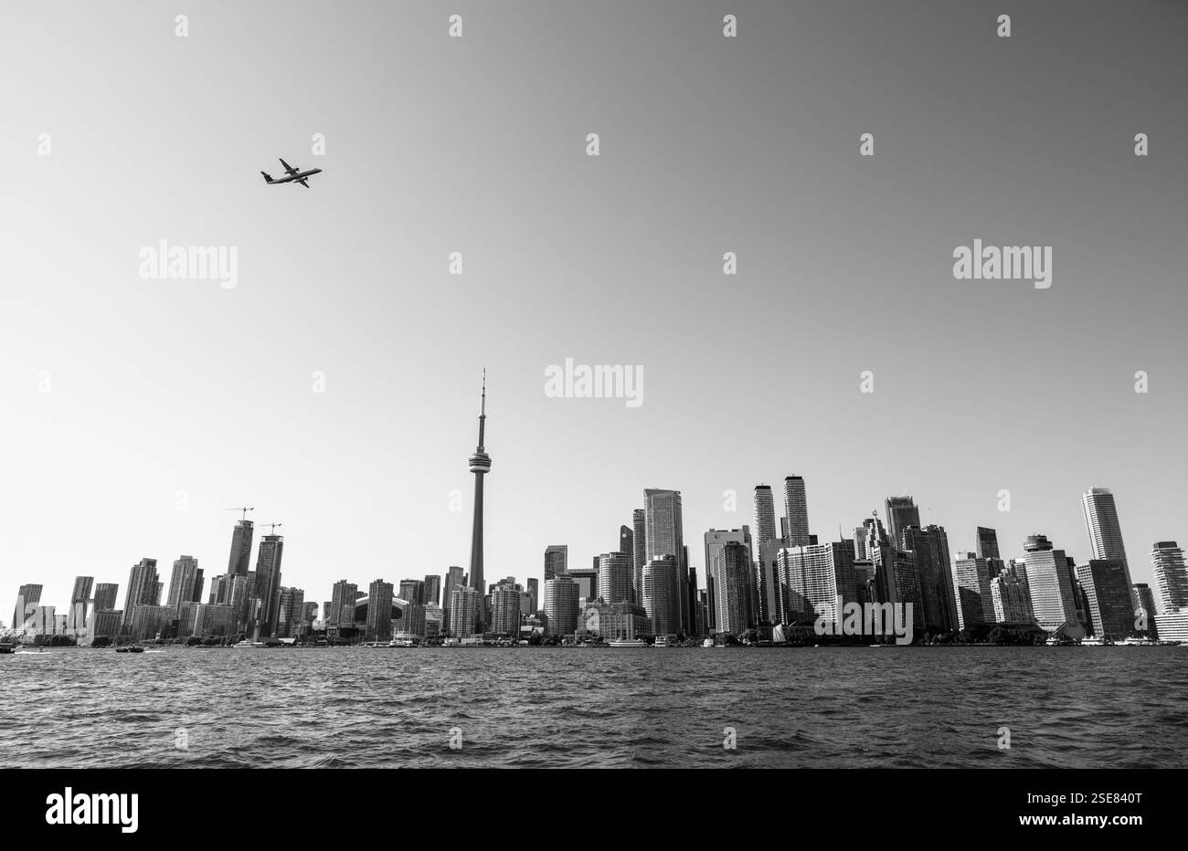 Toronto's skyline dominates the horizon as an airplane ascends above ...