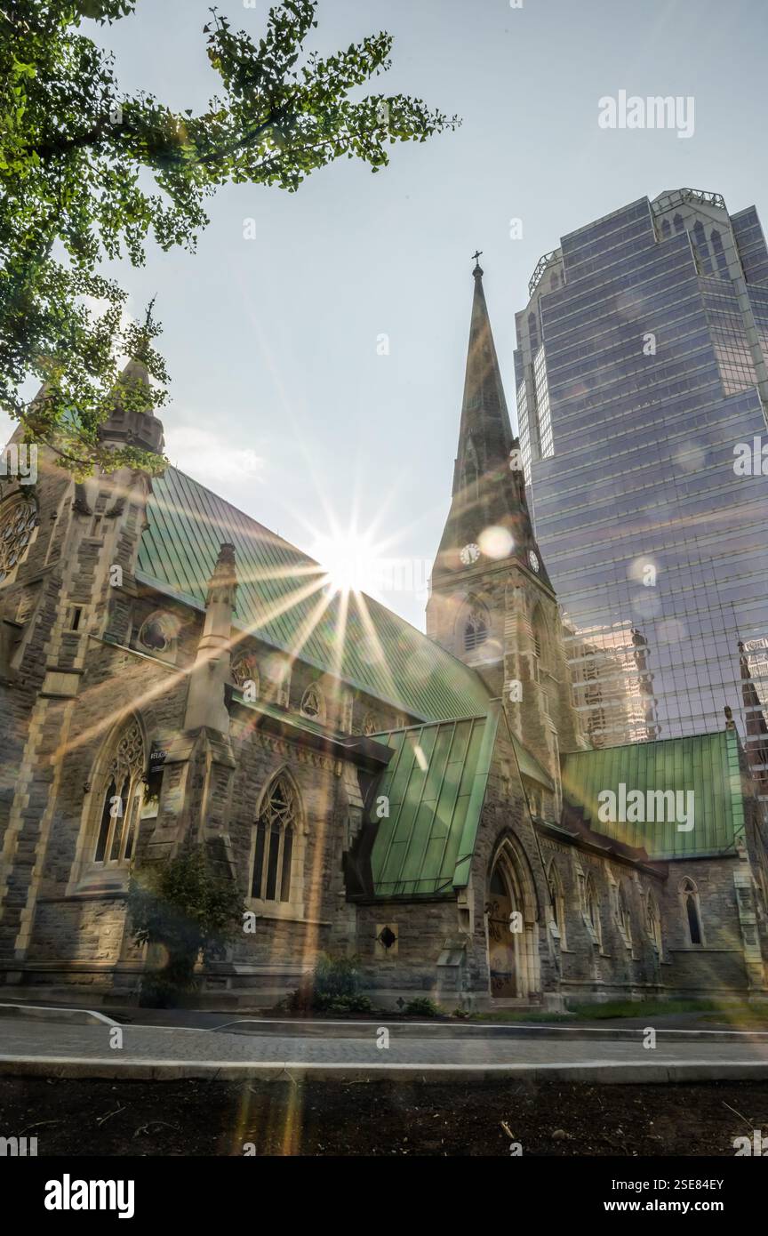 A historic church with a green roof stands proudly next to a tall ...