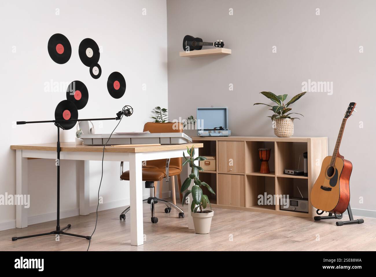 Interior of studio with workplace, shelf unit and musical instruments ...