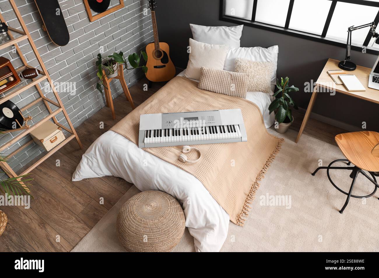 Interior of bedroom with bed and musical instruments Stock Photo - Alamy