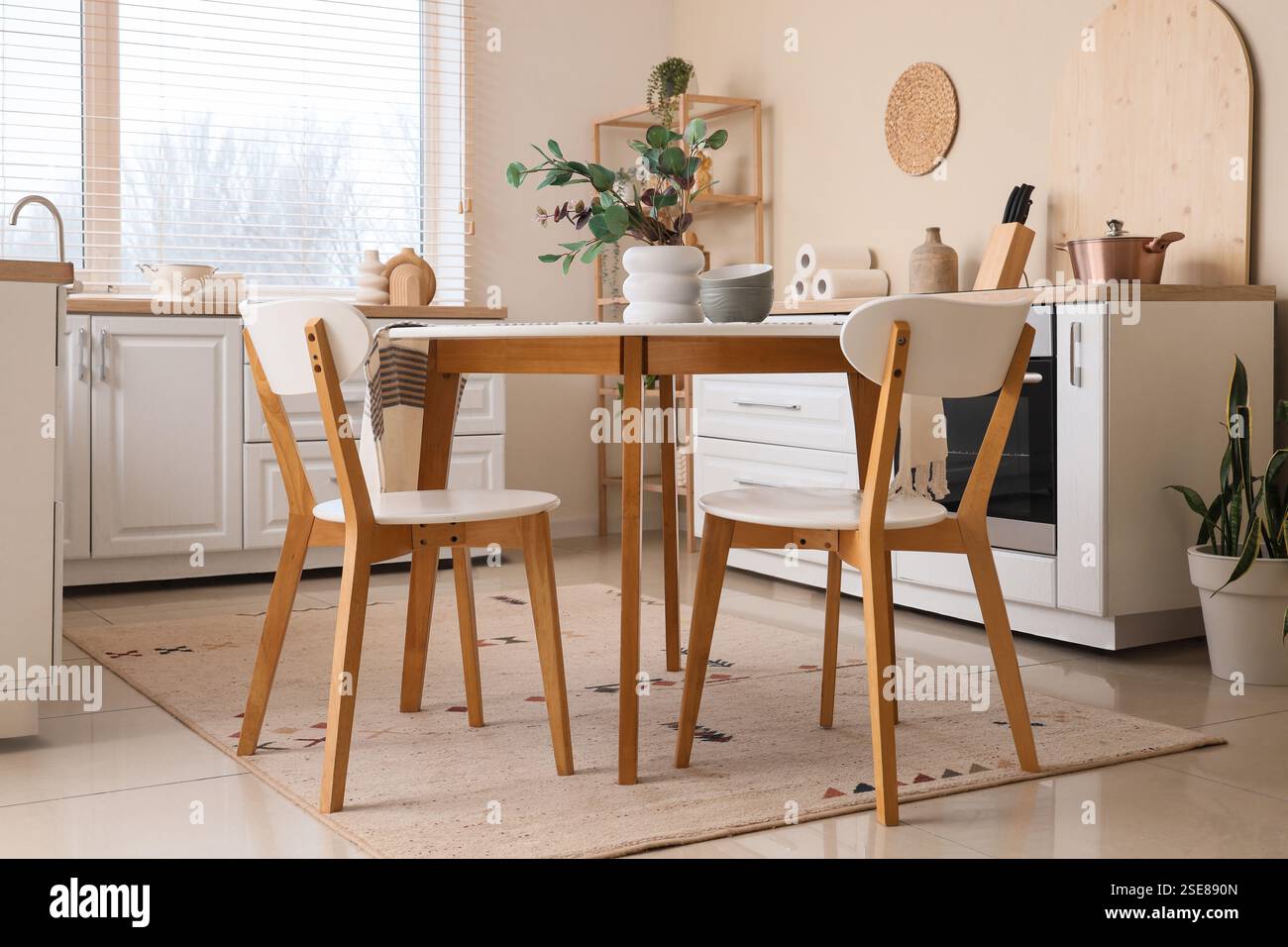 Interior of kitchen with dining table, counters and shelf unit Stock ...