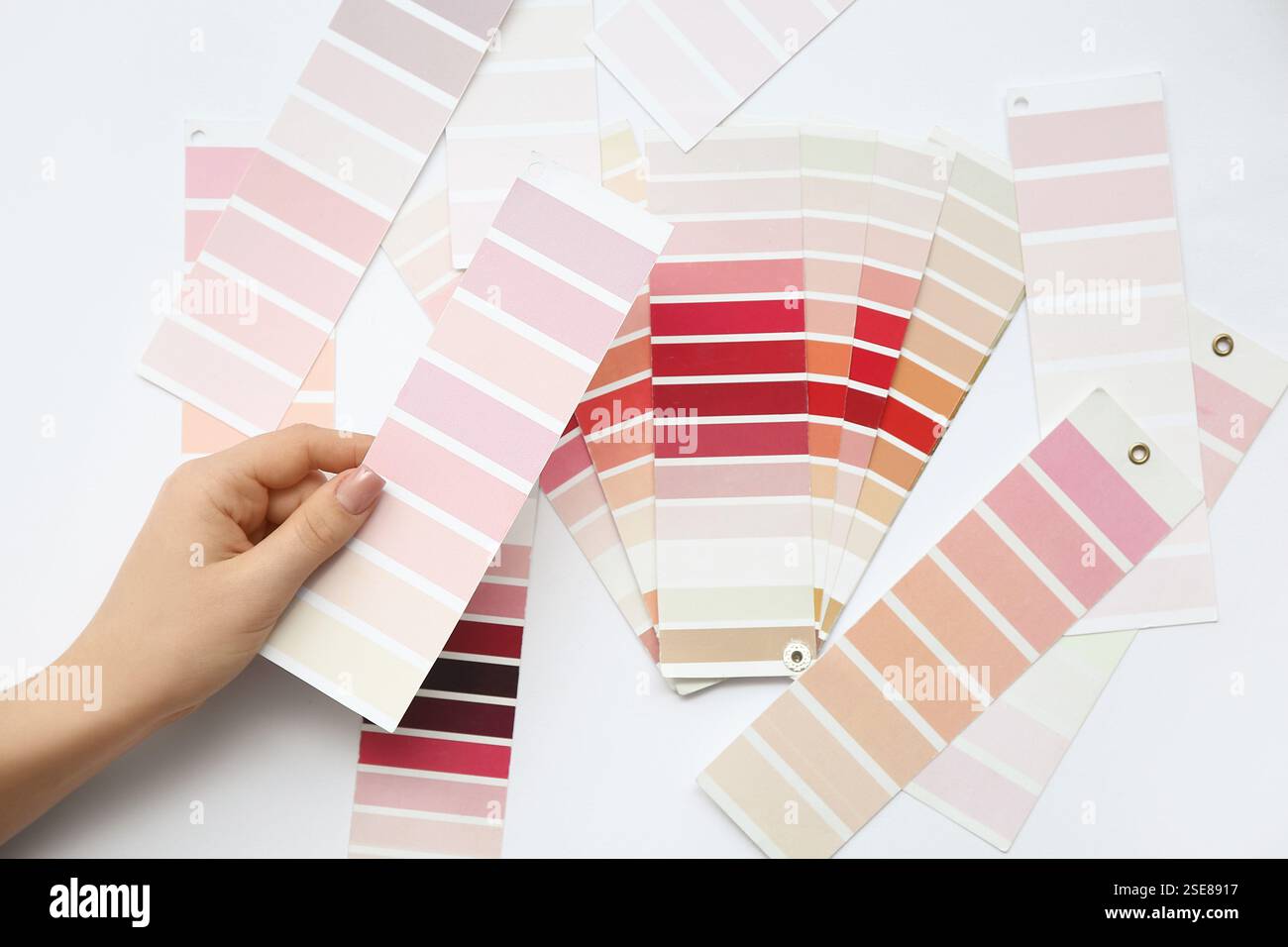 Female hand with different paint color palettes on light background ...