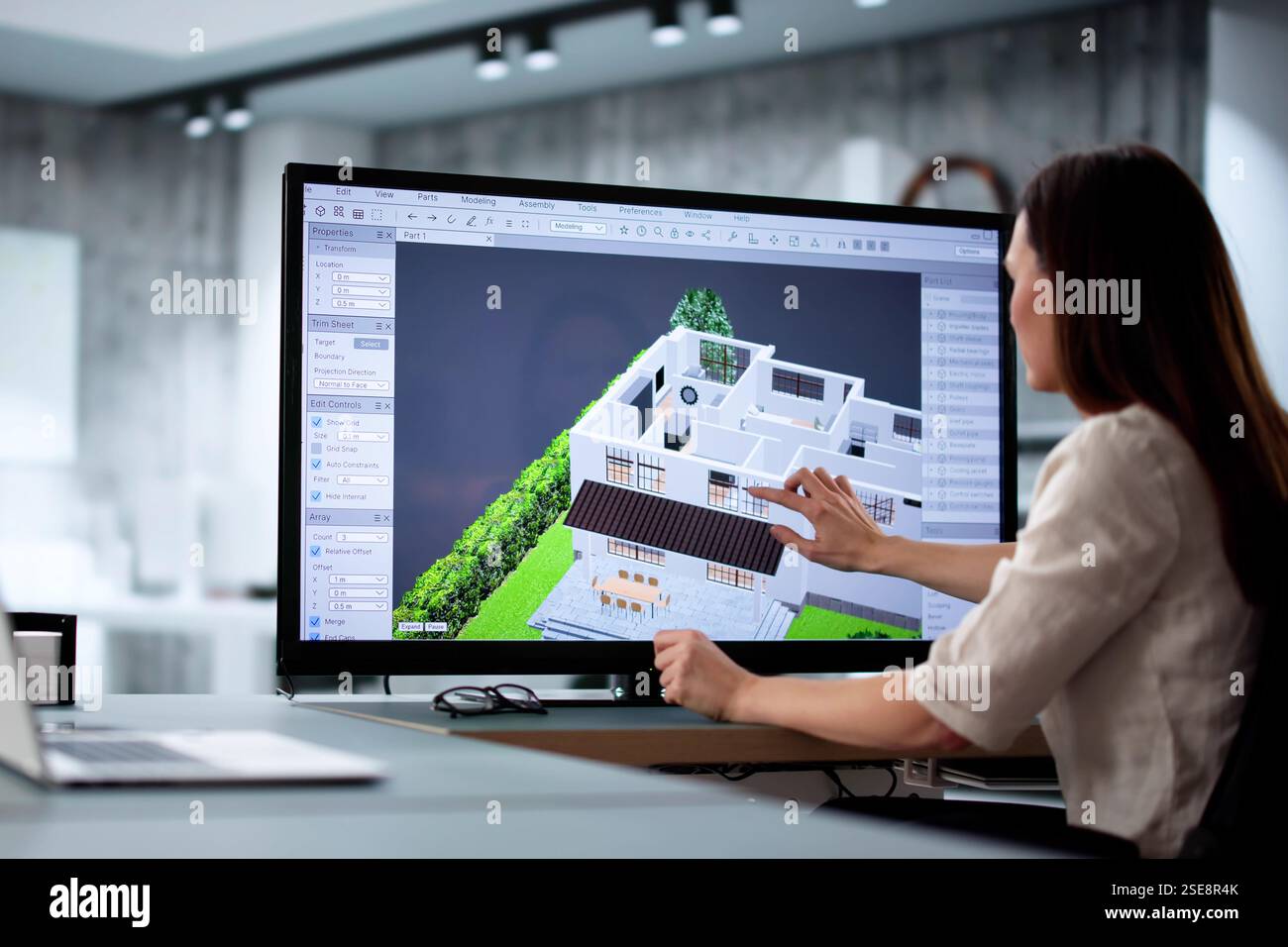 Female architect using 3D software to remodel estate floor plan Stock ...