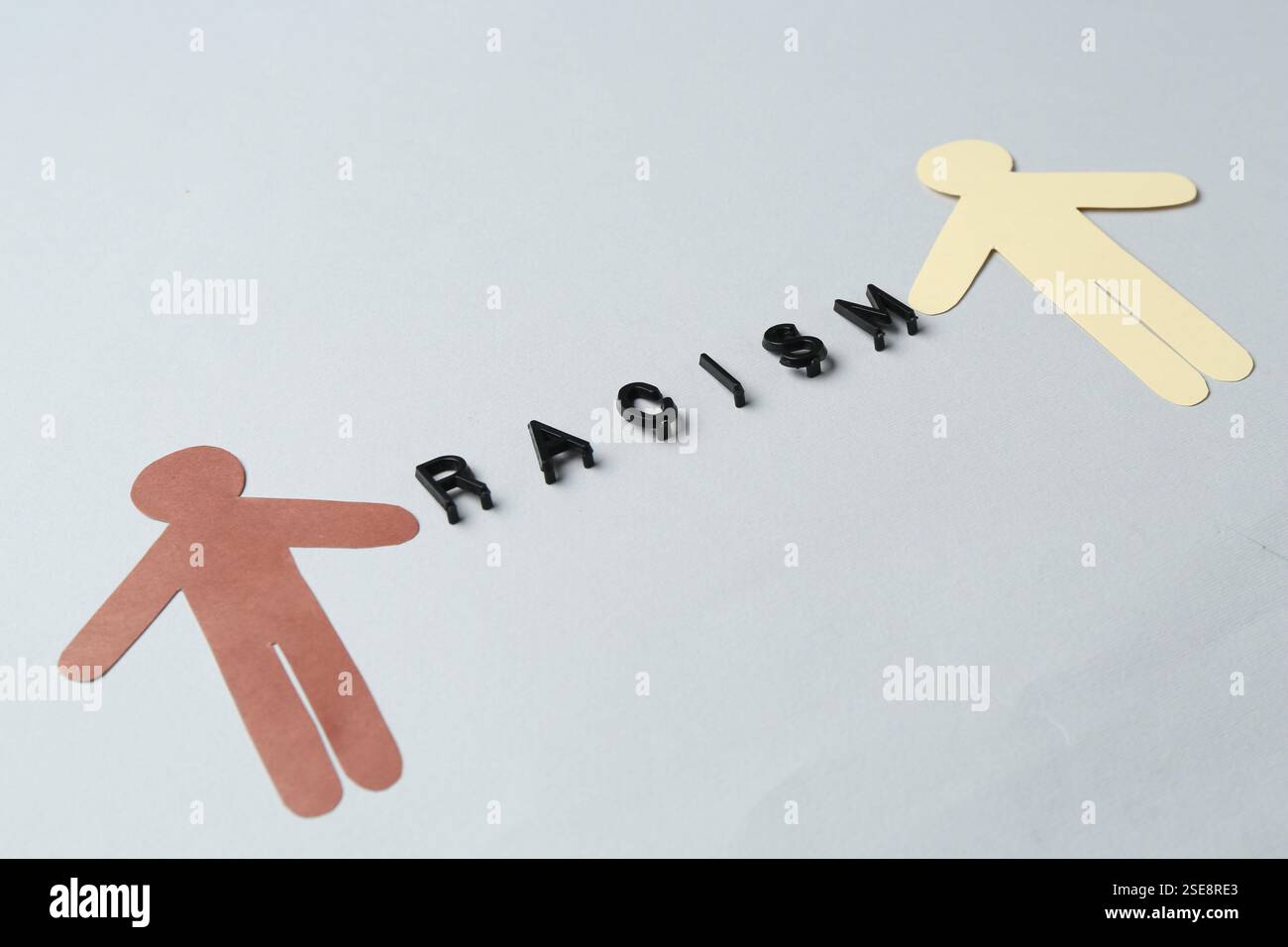 Word Racism and human paper figures of different colors on light grey ...
