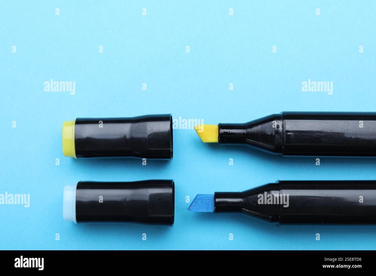 Two color markers on light blue background, top view Stock Photo - Alamy