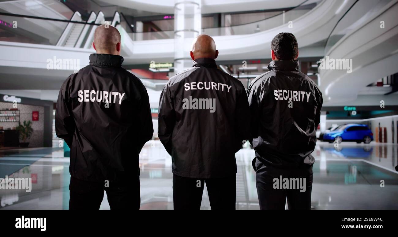 Security Guard Officers Standing In Shopping Mall Protecting Diverse ...
