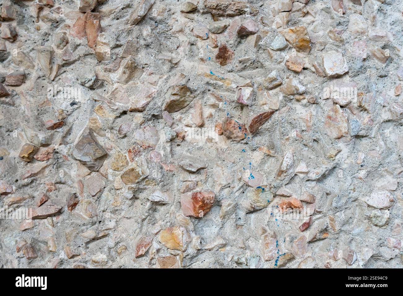 A detailed view of a stone wall showcasing various minerals and gravel ...