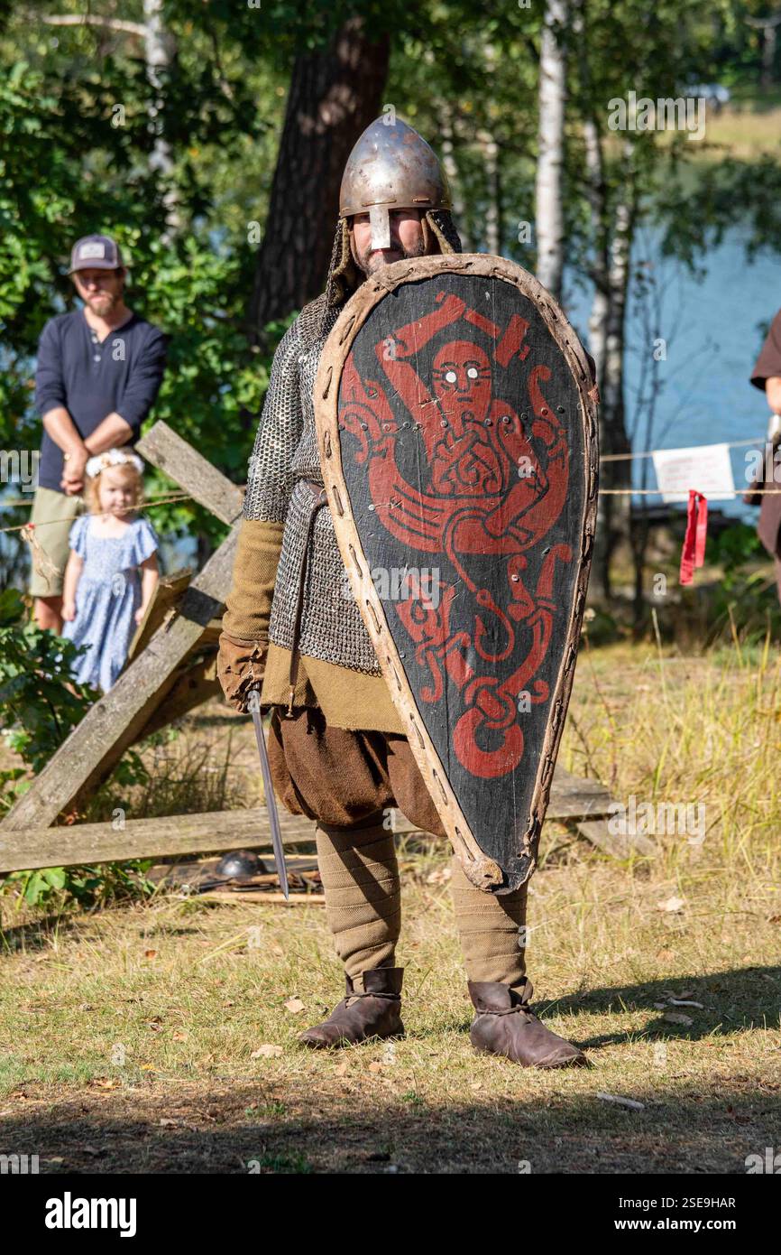 Re-enactor with nasal helmet, chain mail armor and kite shield at ...