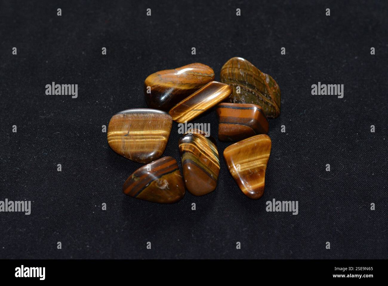 A collection of raw tiger's eye gemstones, showcasing their natural ...