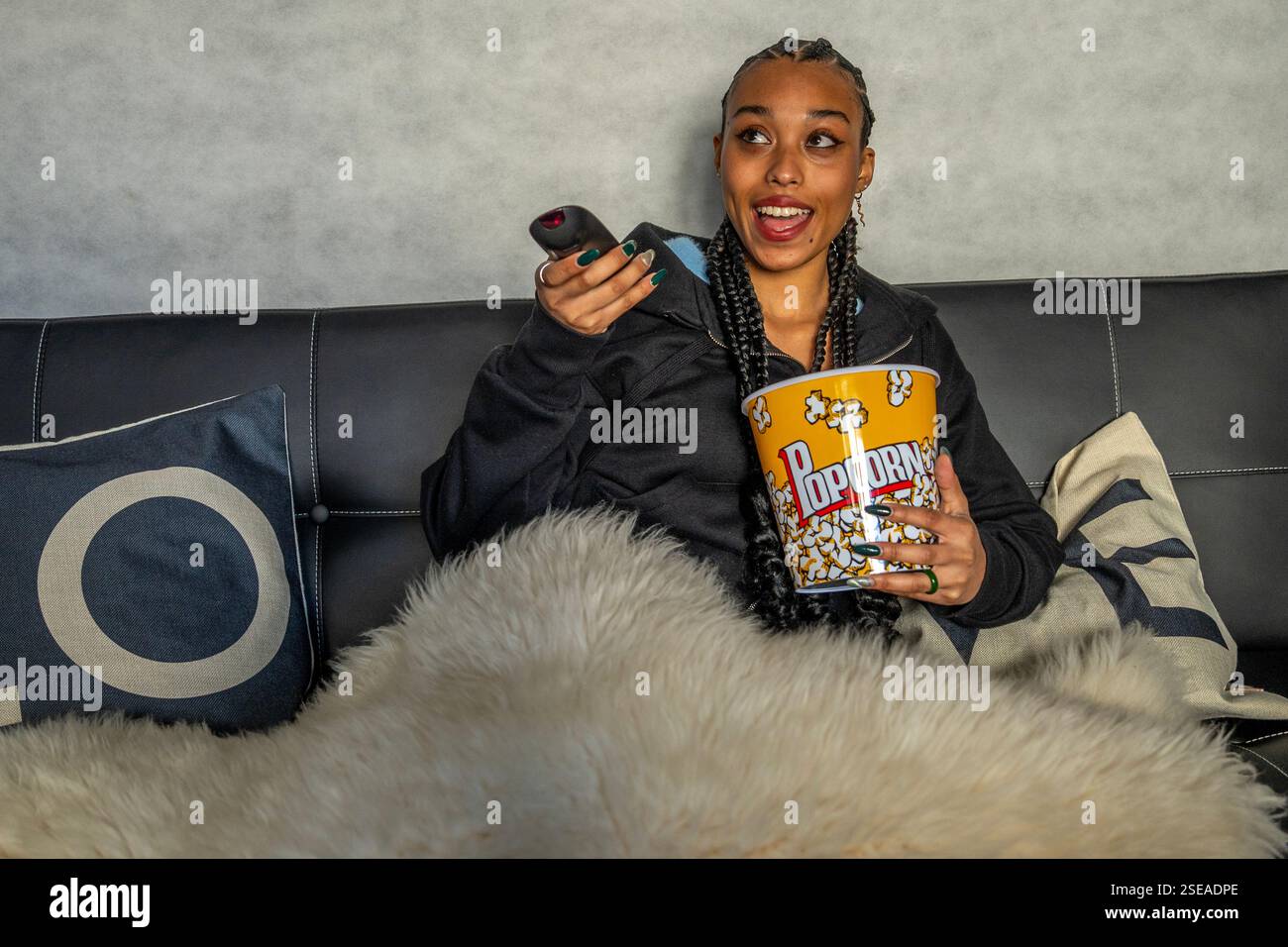 Woman holding bucket popcorn hi-res stock photography and images - Alamy