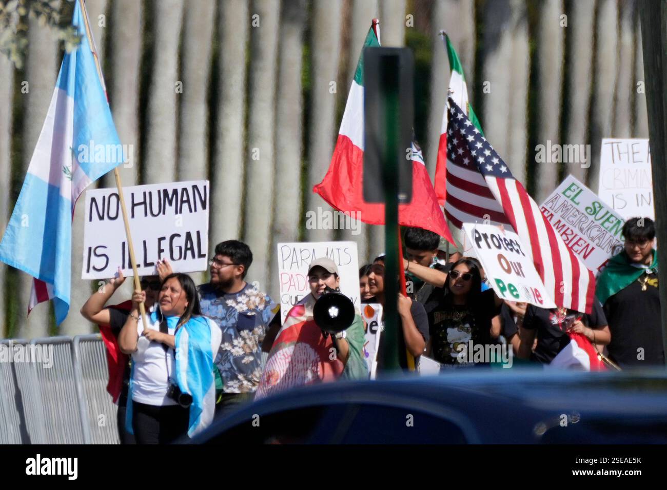Demonstrators carrying American flags, Mexican flags and Guatemalan ...