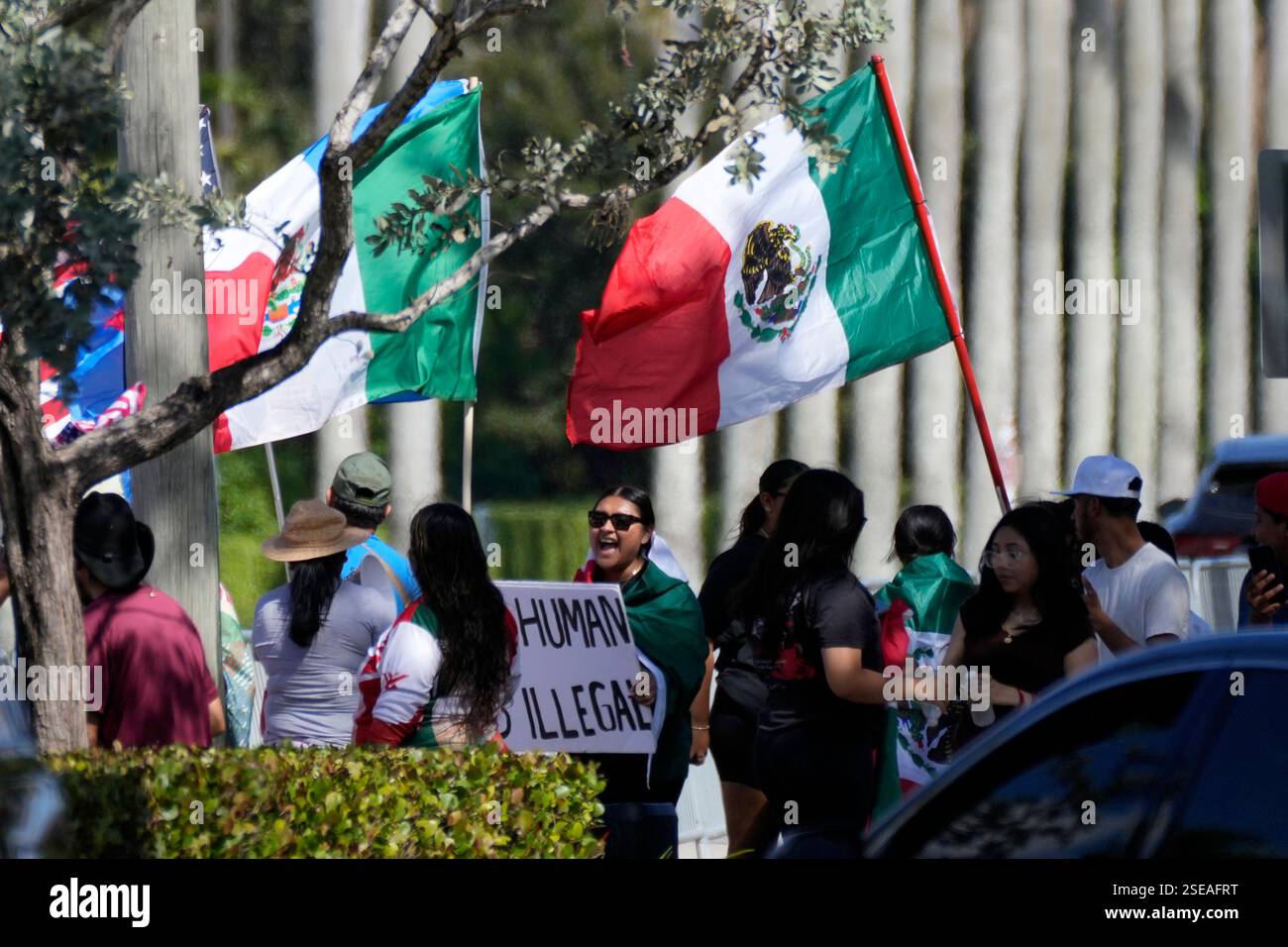Demonstrators carrying American flags and Mexican flags protest outside ...