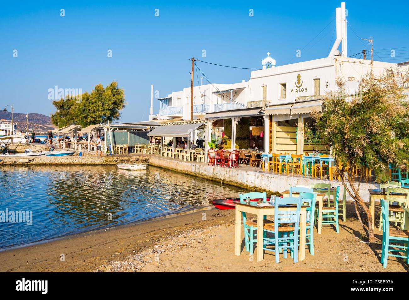 POLLONIA PORT, MILOS ISLAND - SEP 23, 2023: Tables and chairs in ...