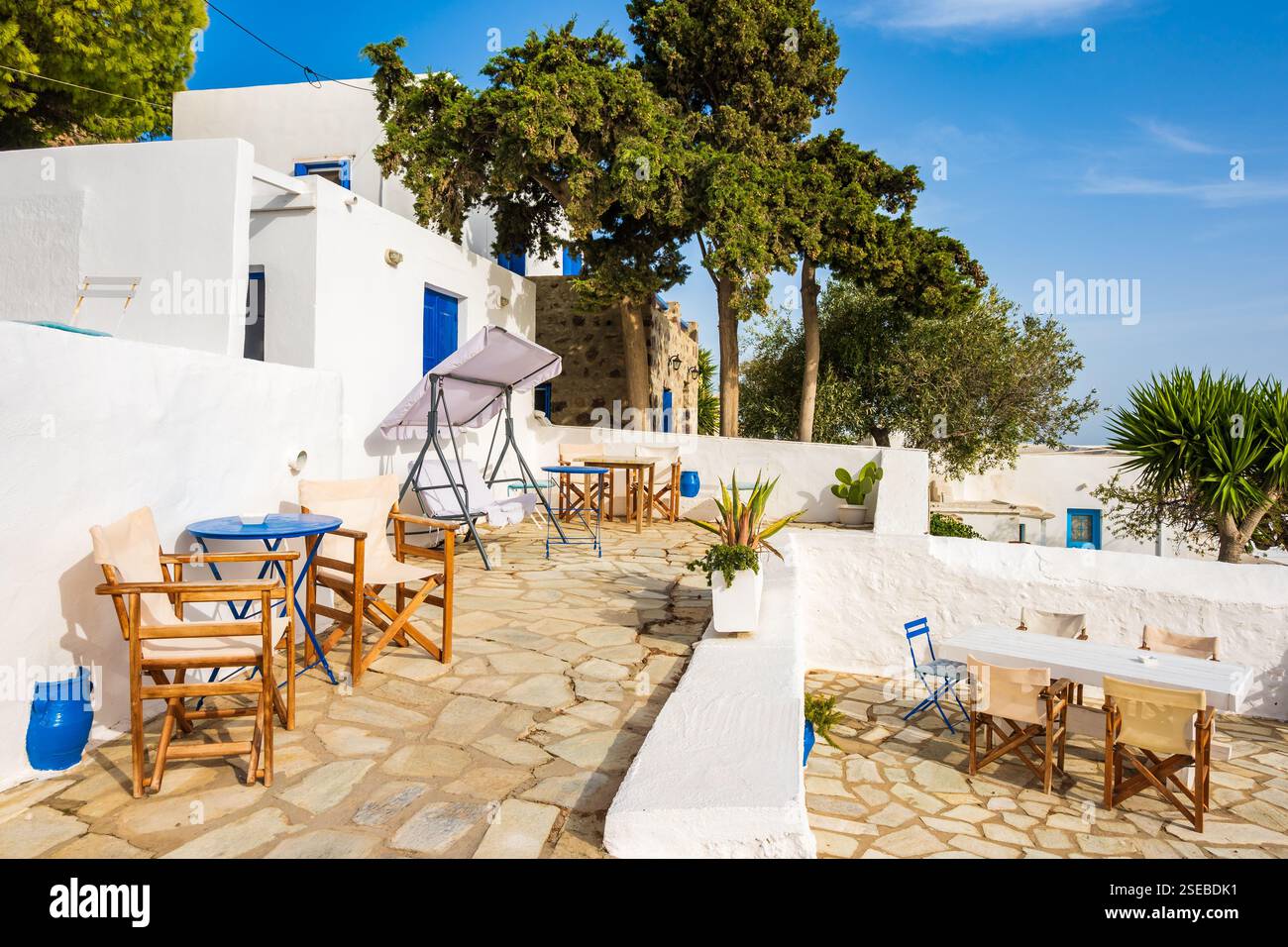 Chairs with tables on terrace with typical Greek architecture in Plaka ...