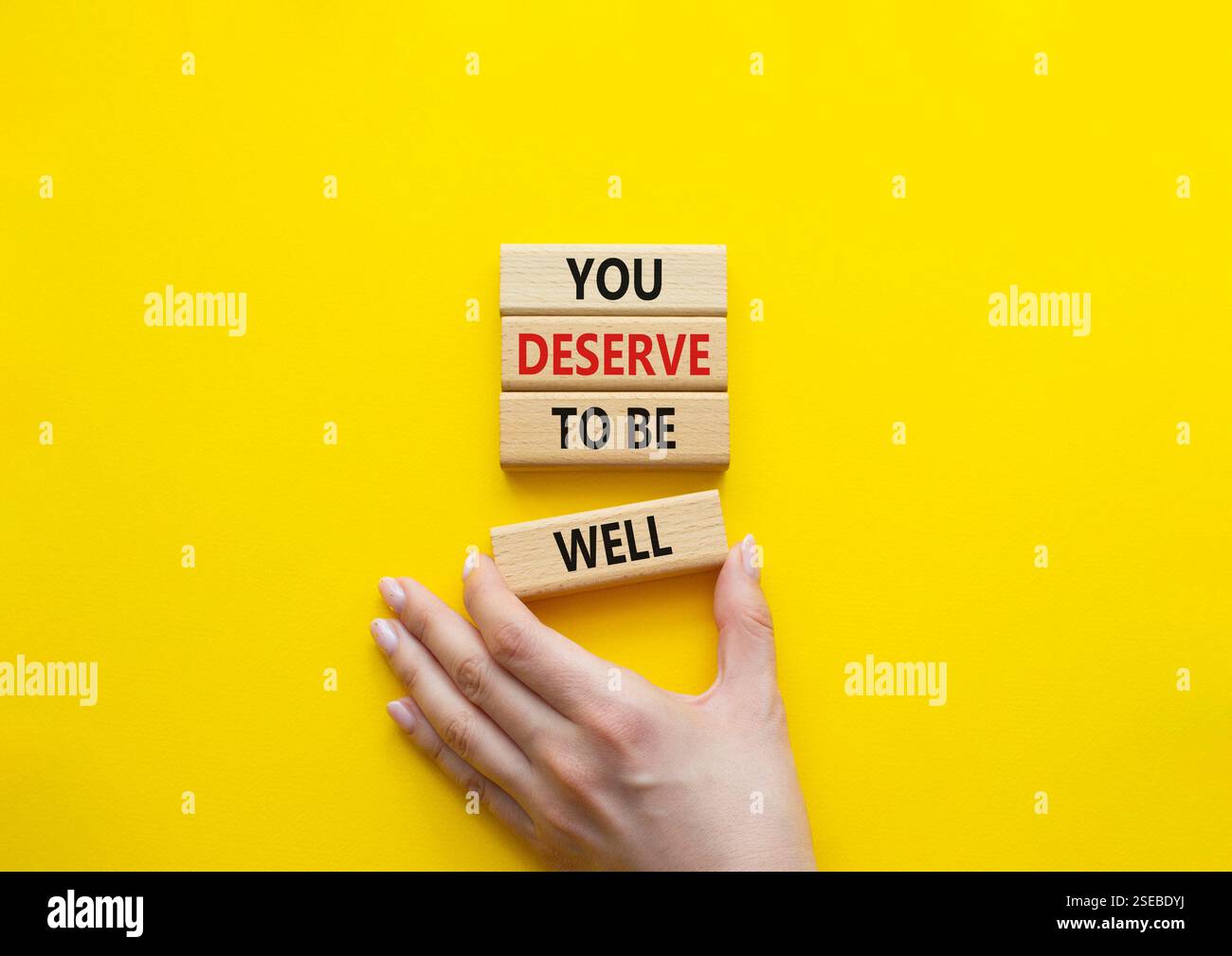 You deserve to be well symbol. Wooden blocks with words You deserve to ...
