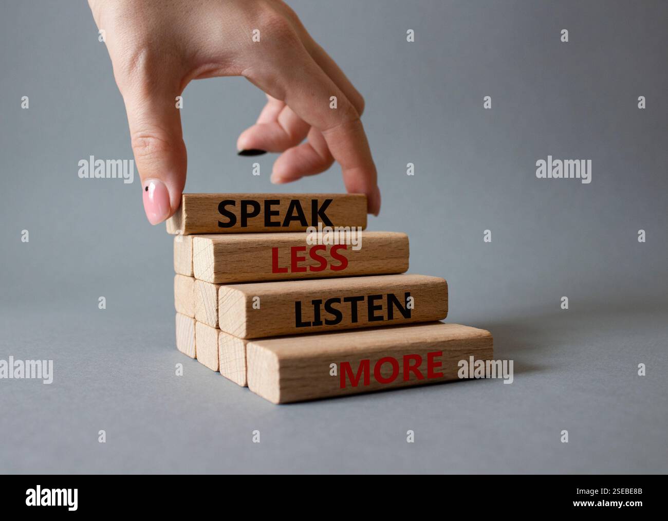 Speak less Listen more symbol. Wooden blocks with words Speak less ...