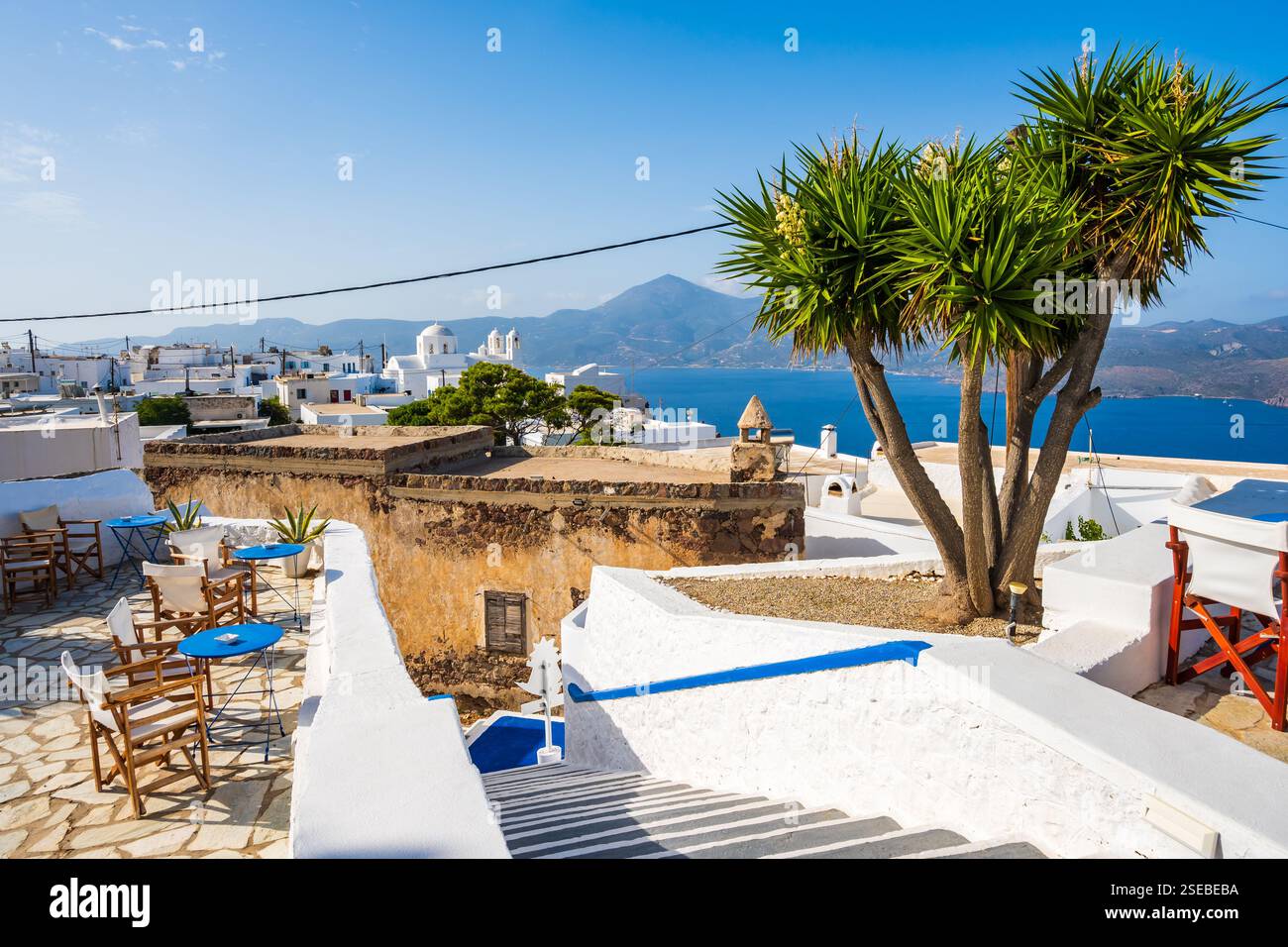 Chairs with tables on terrace with typical Greek architecture in Plaka ...