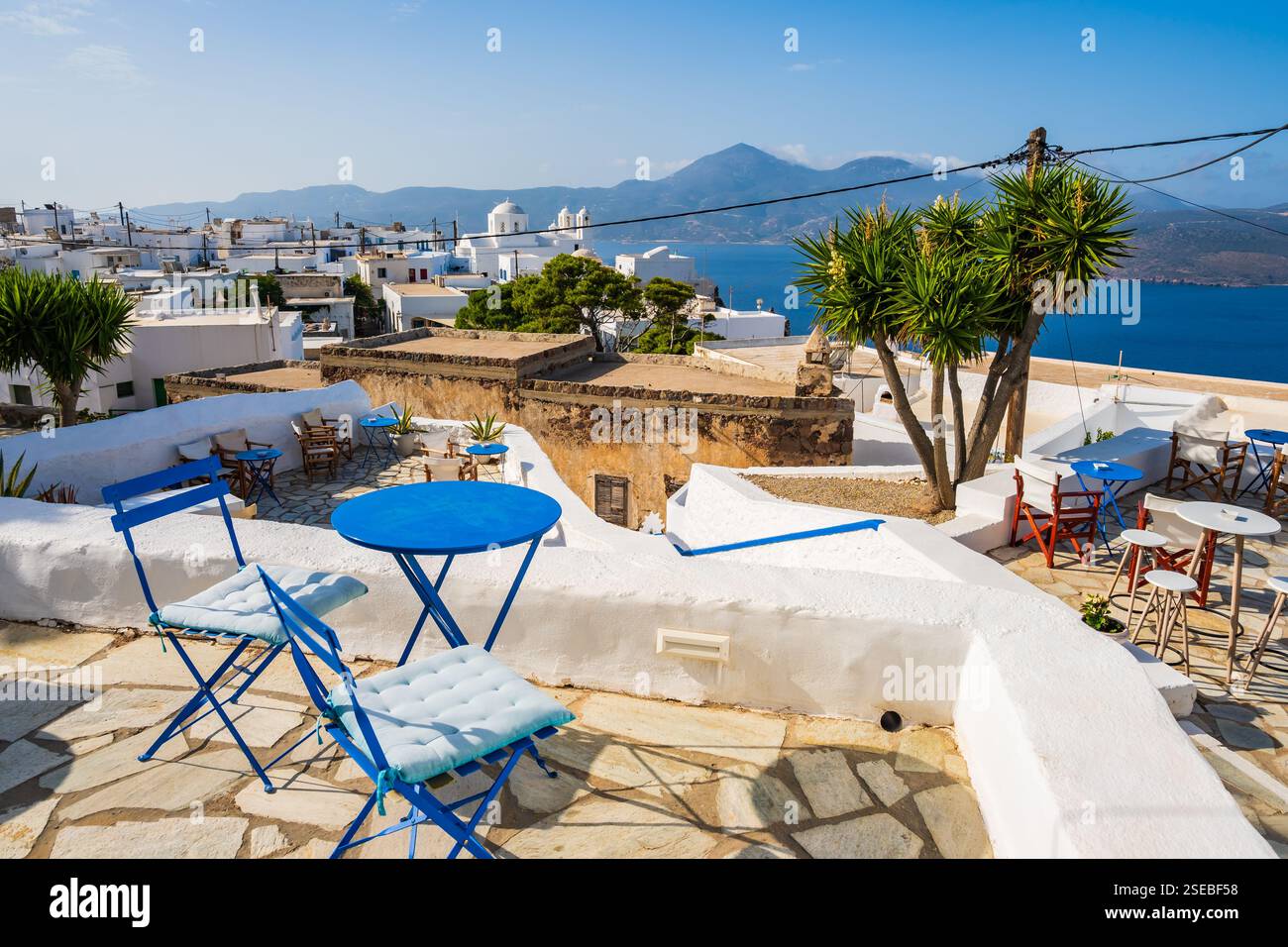 Chairs with tables on terrace with typical Greek architecture in Plaka ...