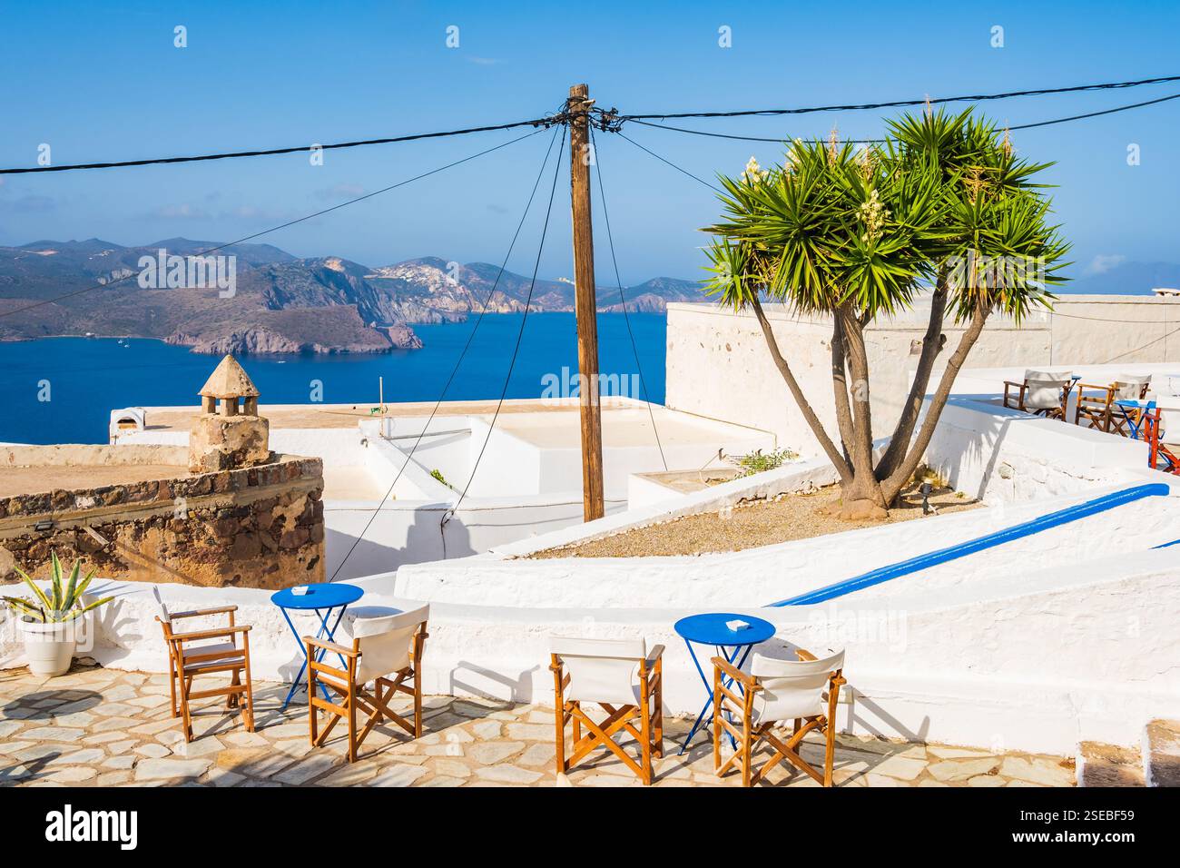 Chairs with tables on terrace with typical Greek architecture in Plaka ...