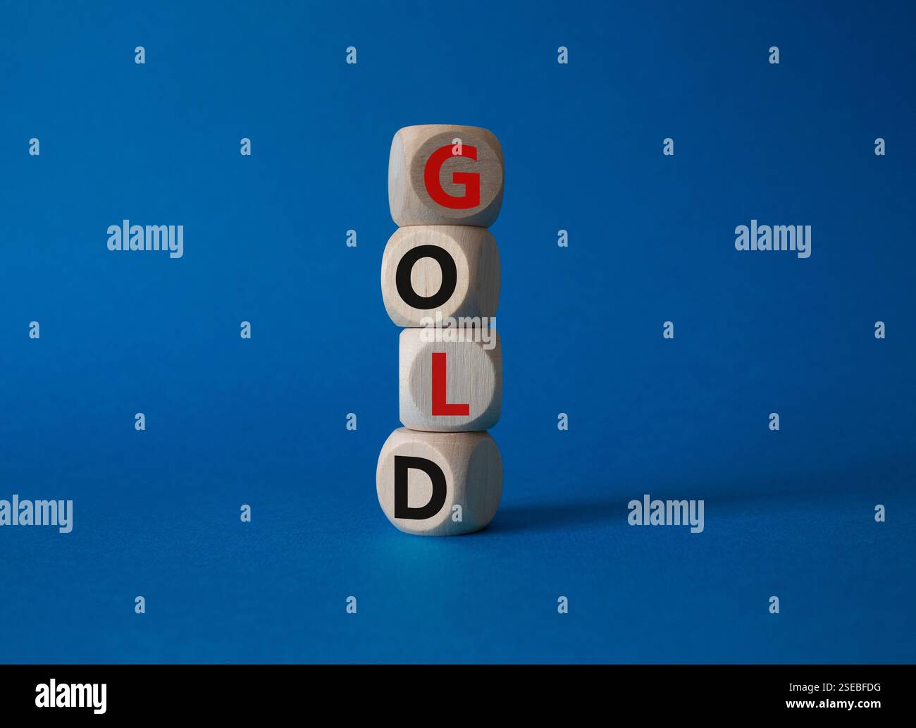 Gold symbol. Concept word Gold on wooden cubes. Beautiful blue ...