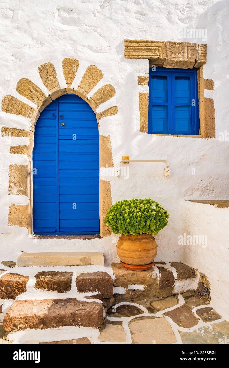 Typical white Greek house with blue door and window in Plaka village ...