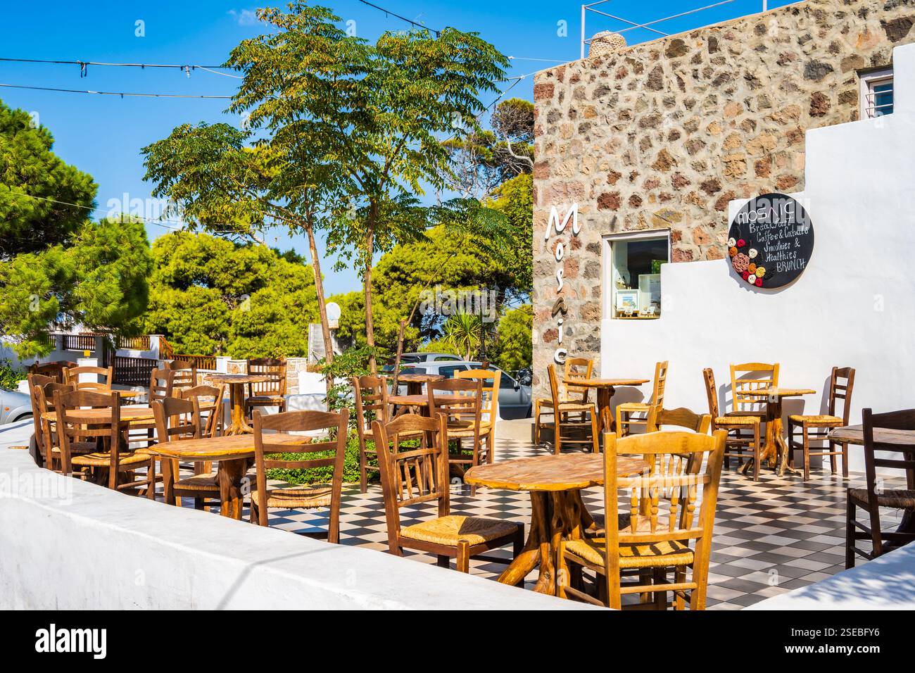 PLAKA VILLAGE, MILOS ISLAND - SEP 25, 2023: Chairs with tables in ...