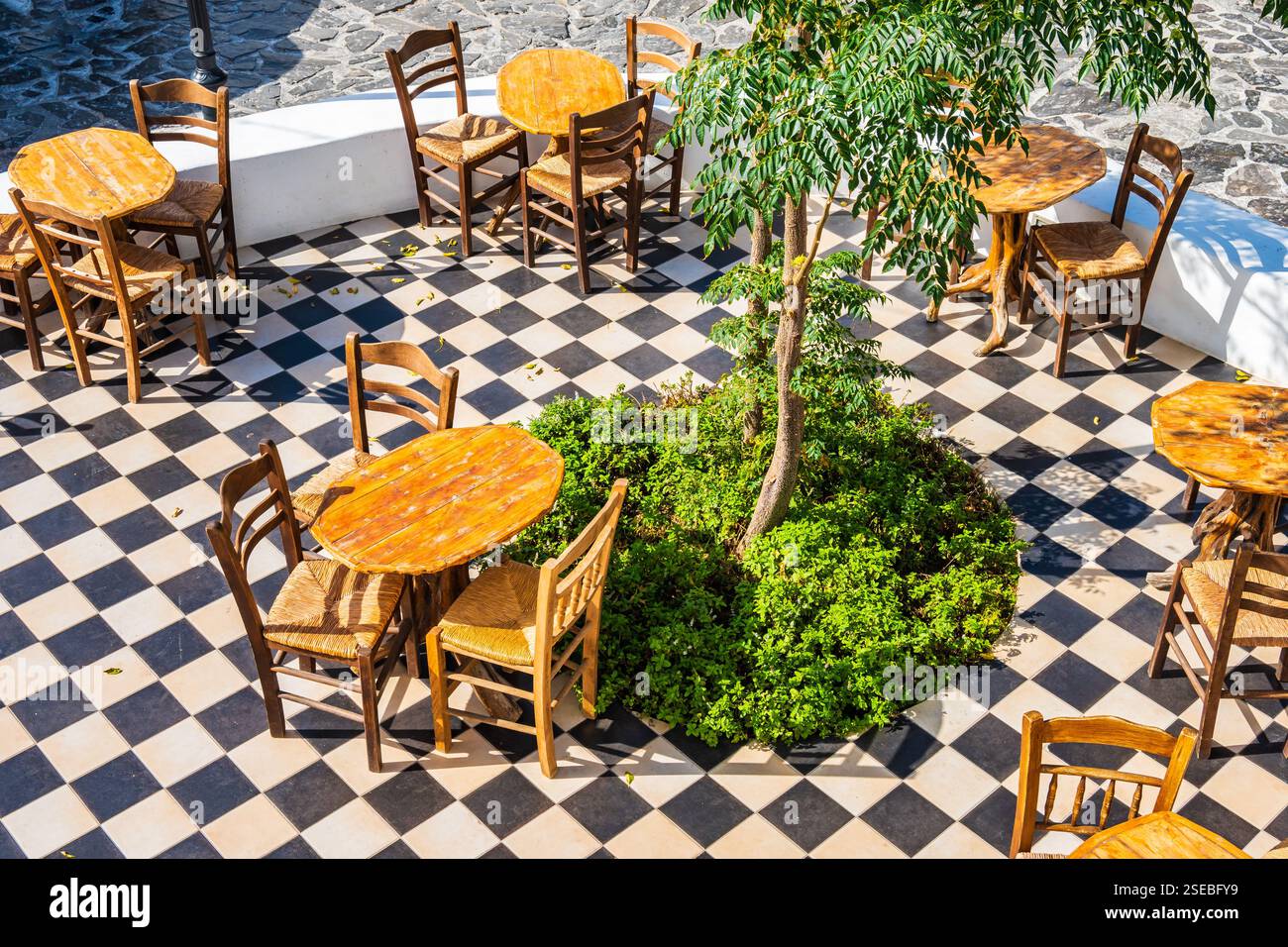 Chairs with tables in traditional Greek restaurant tavern in Plaka ...