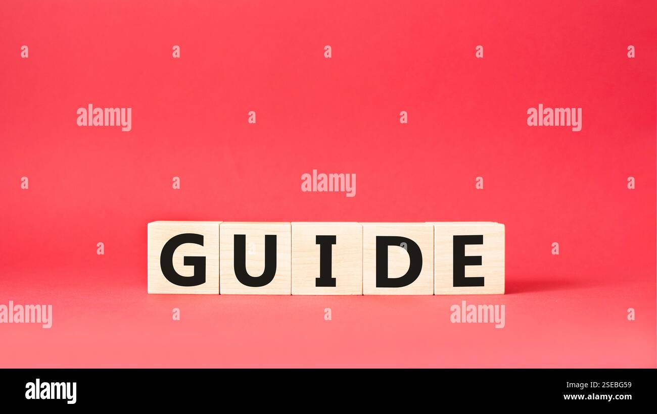 Guide symbol. Wooden cubes with word Guide. Beautiful red background ...