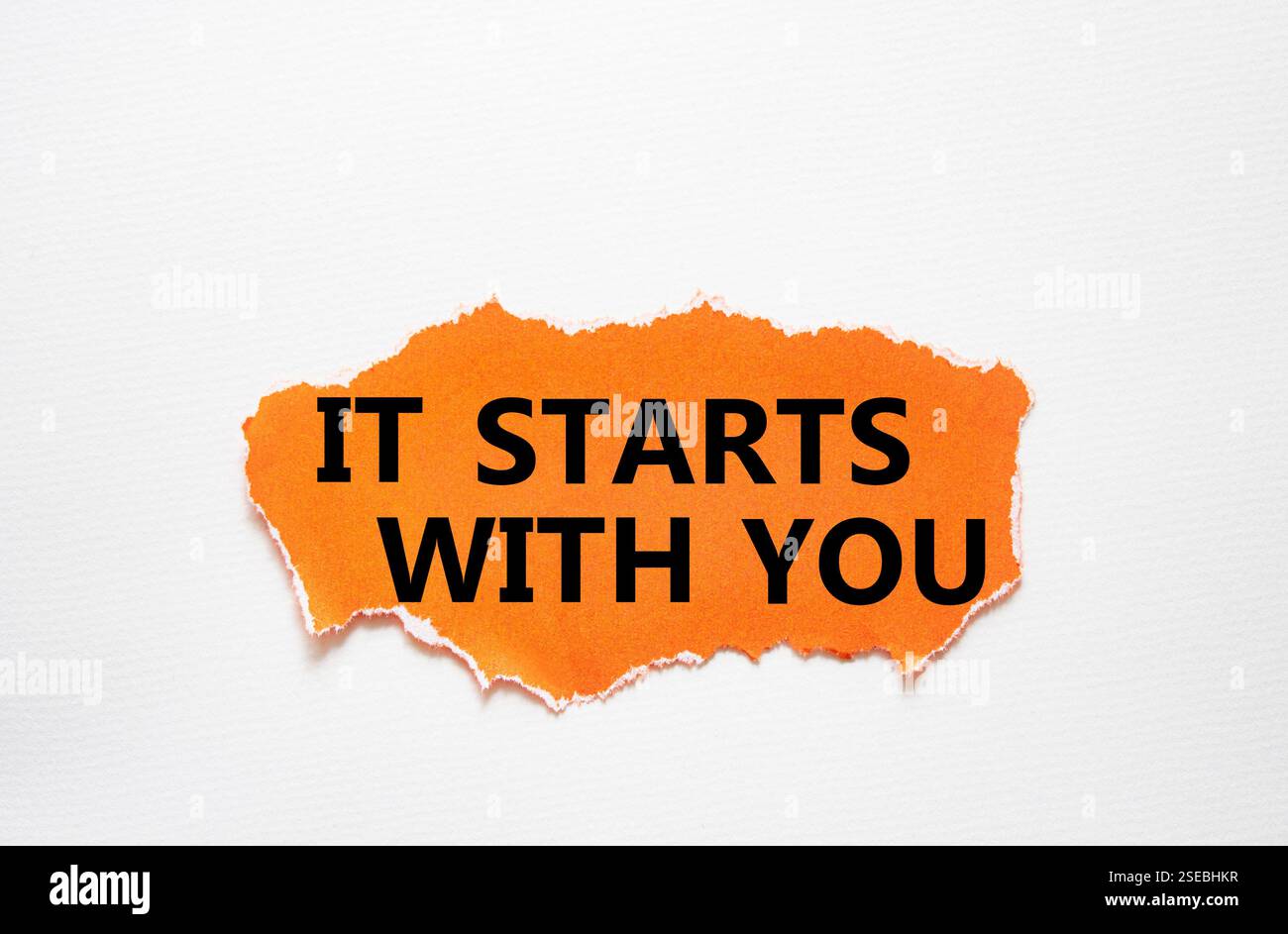 It starts with you symbol. Torn orange paper with words It starts with ...