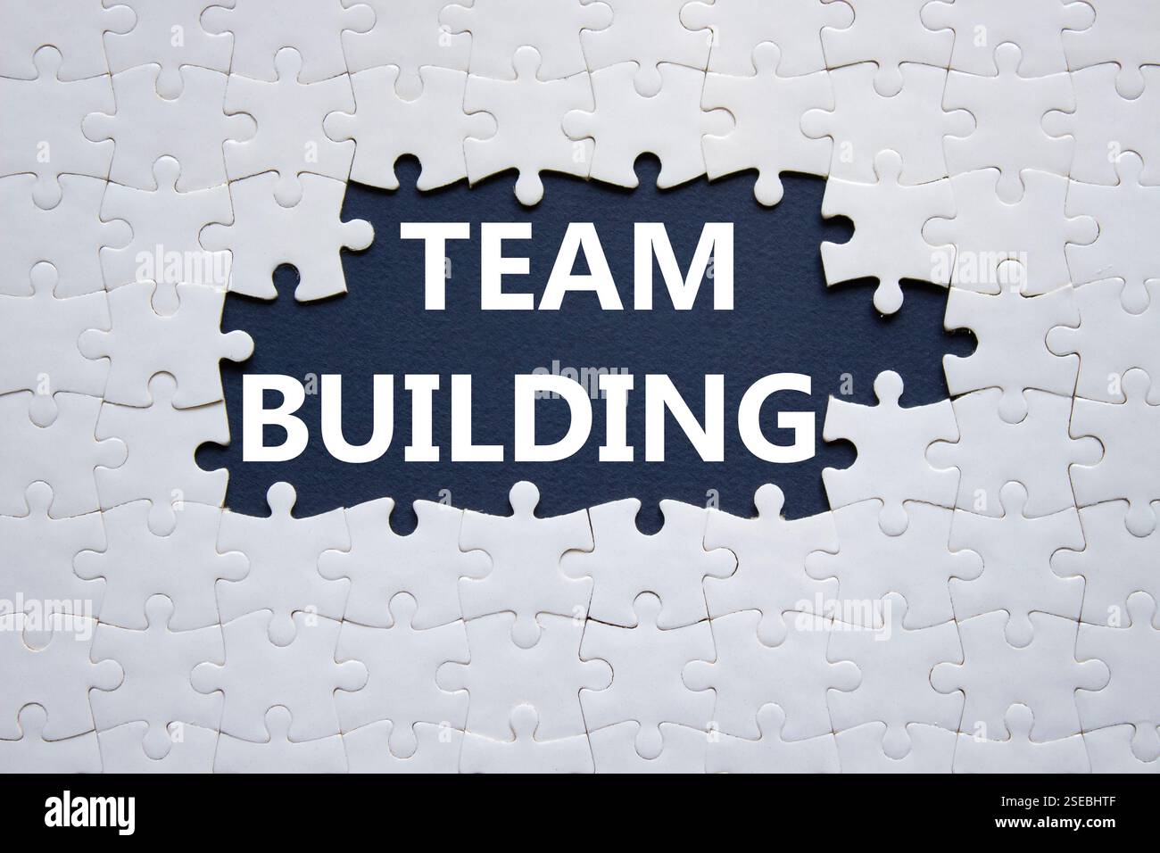 Team Building symbol. Concept word Team Building on white puzzle ...