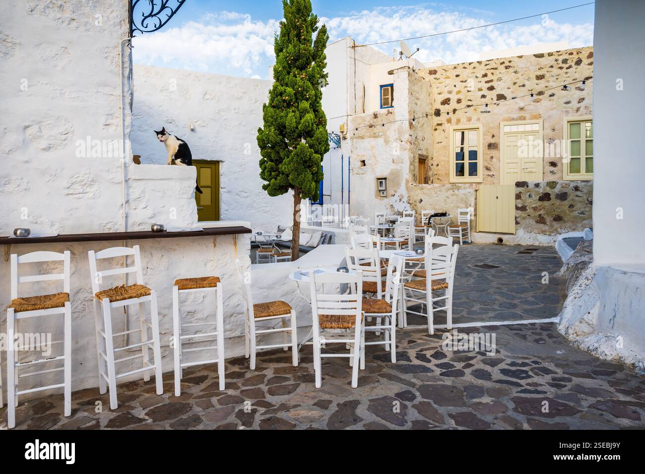 Narrow streets of Plaka village with traditional white houses with ...