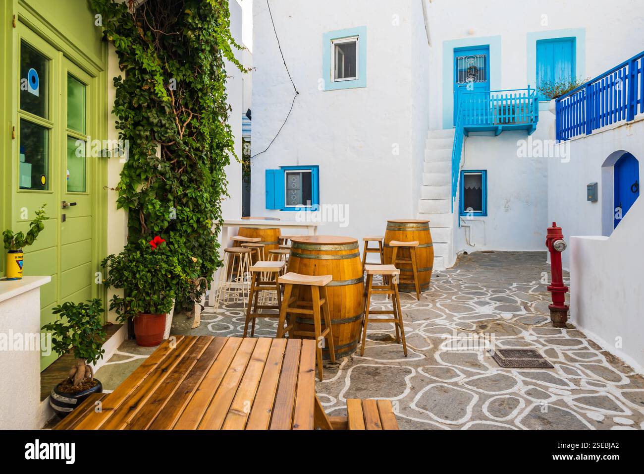 Narrow streets of Plaka village with traditional white houses with ...