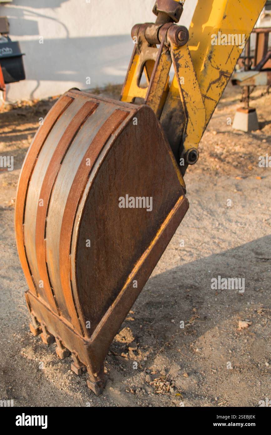 The heavy duty steel bucket on a backhoe. Construction equipment for ...