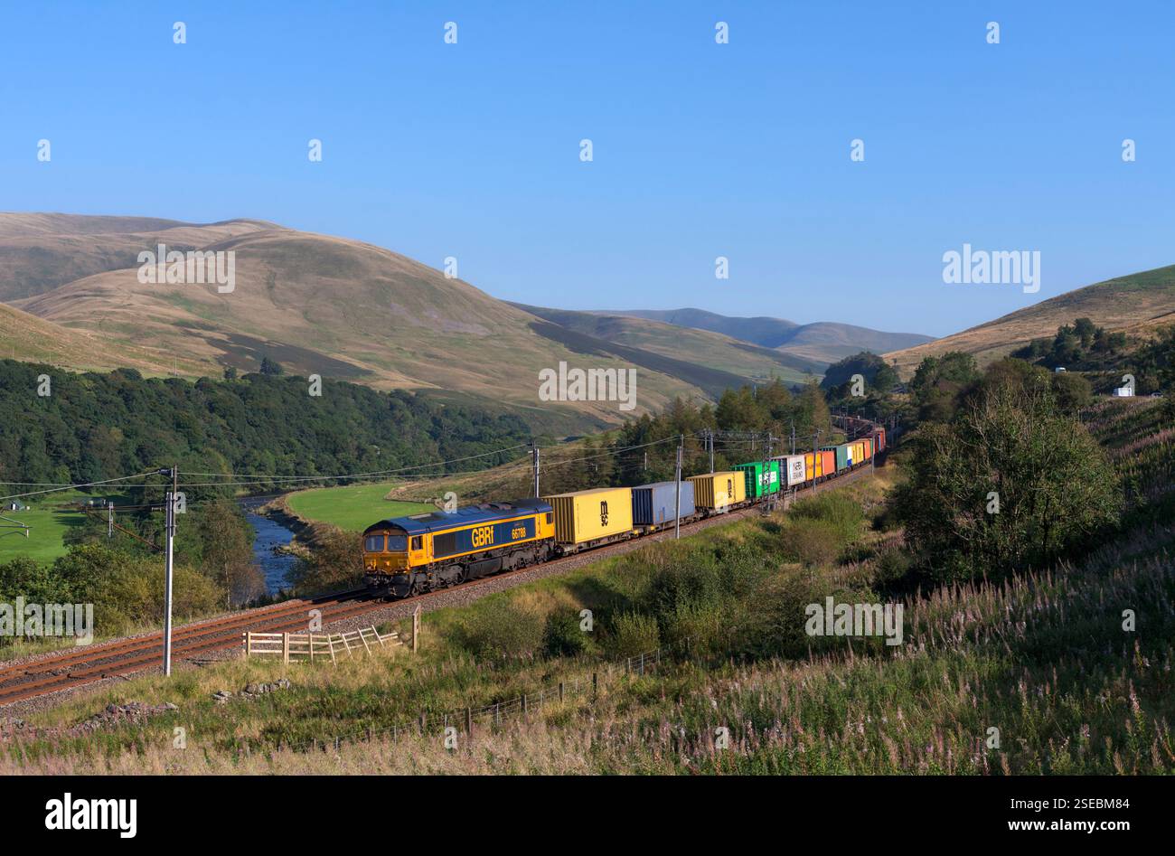 GB Rail Freight 66 diesel locomotive on the west coast main line with ...