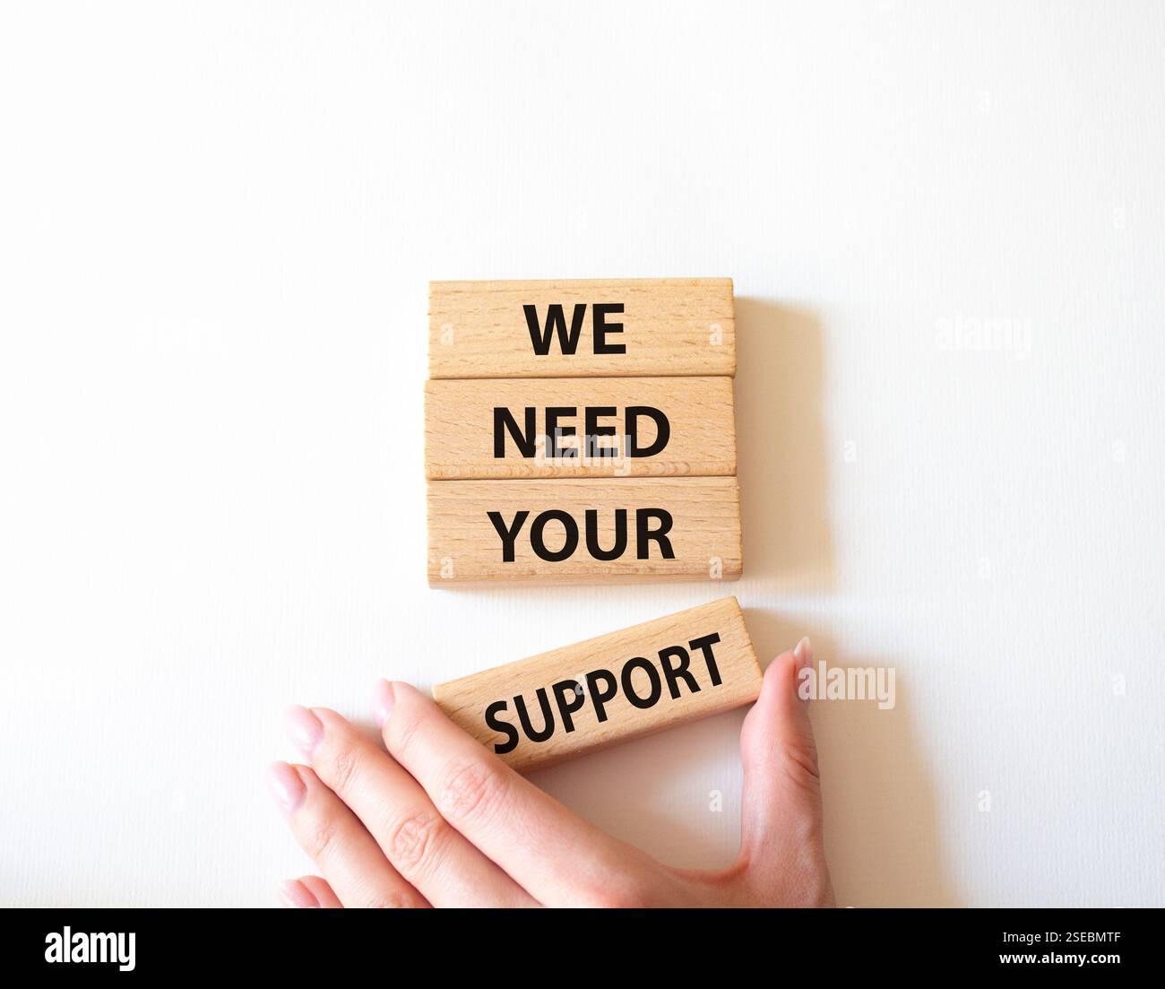 We need your support symbol. Wooden blocks with words We need your ...