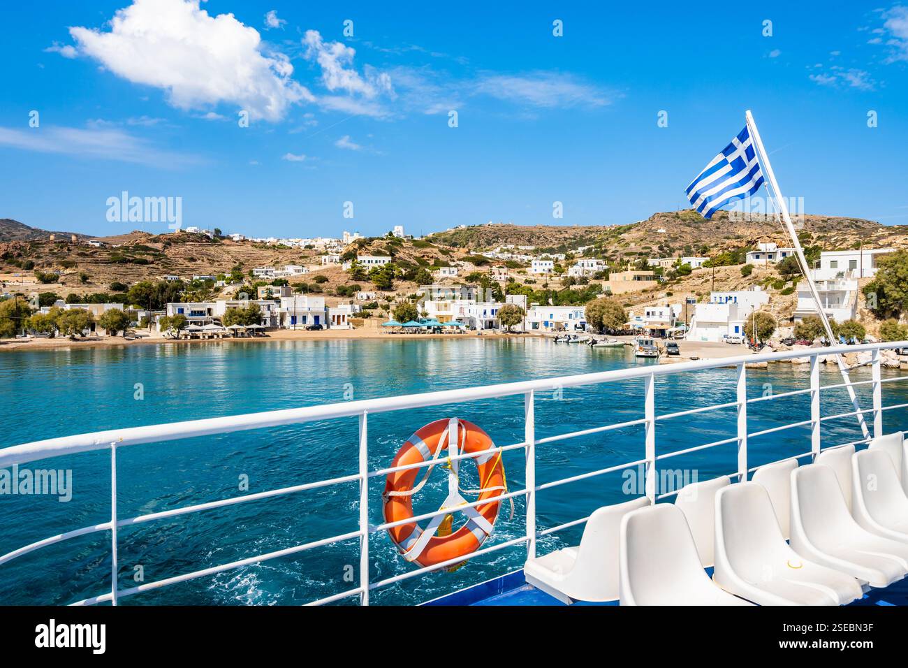 Deck of ferry with Greek flag leaving Milos island and sailing to ...