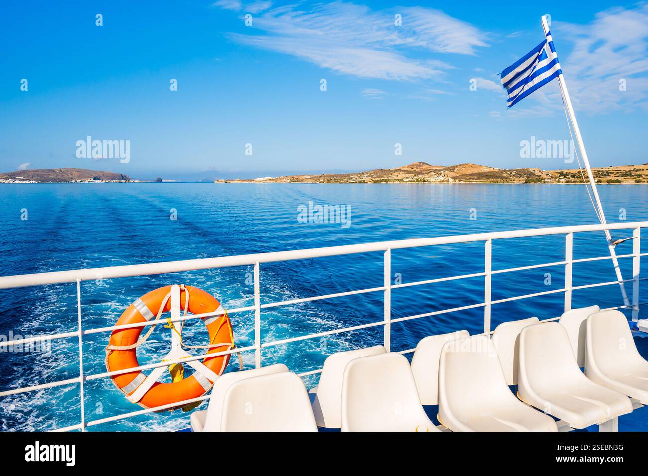 View of sea and Greek flag from deck ferry from Kimolos, Milos island ...