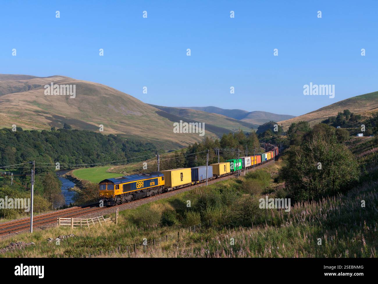 GB Rail Freight 66 diesel locomotive on the west coast main line with ...