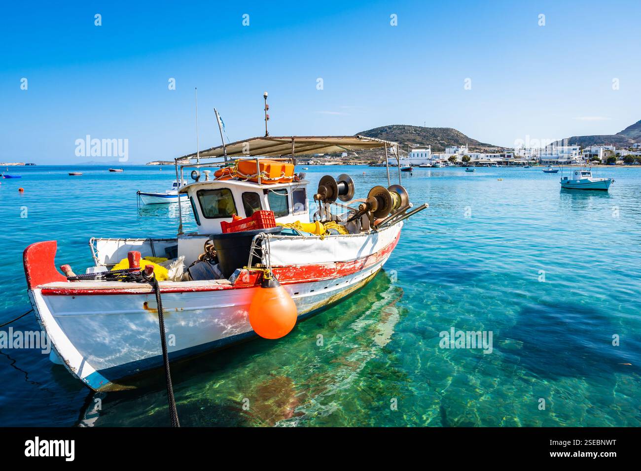 Colorful fishing boat on azure sea in Pollonia port, Milos island ...