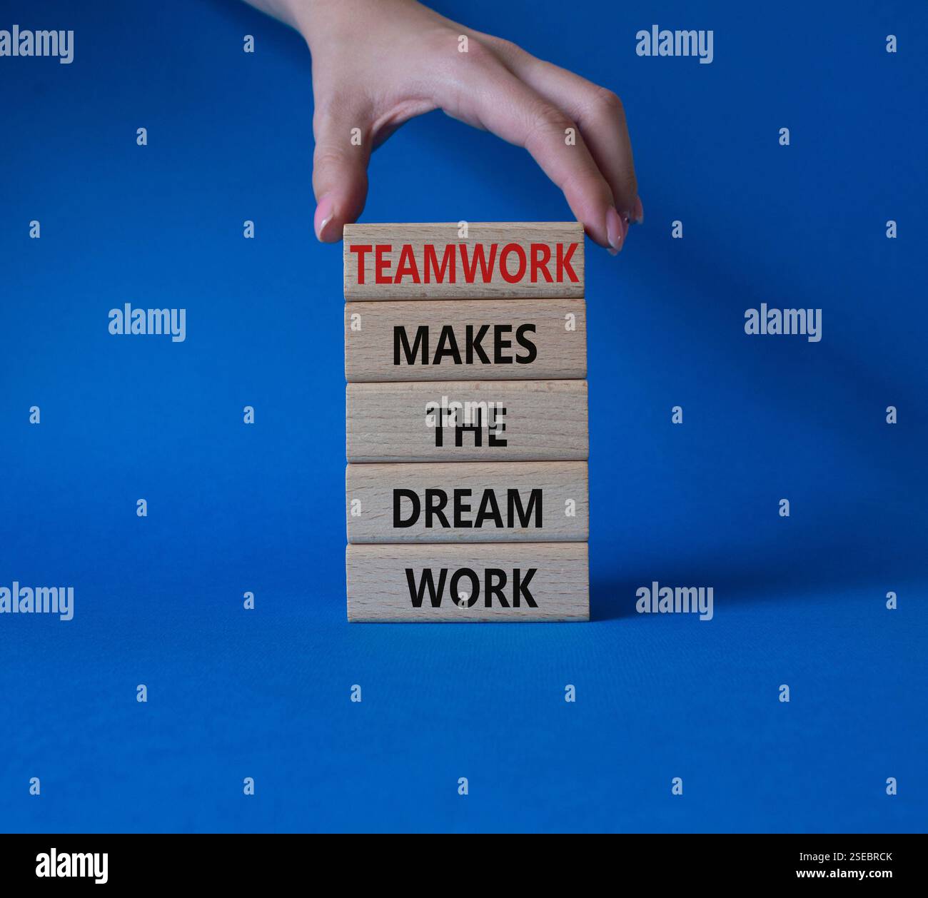 Teamwork symbol. Wooden blocks with words Teamwork makes the Dream work ...
