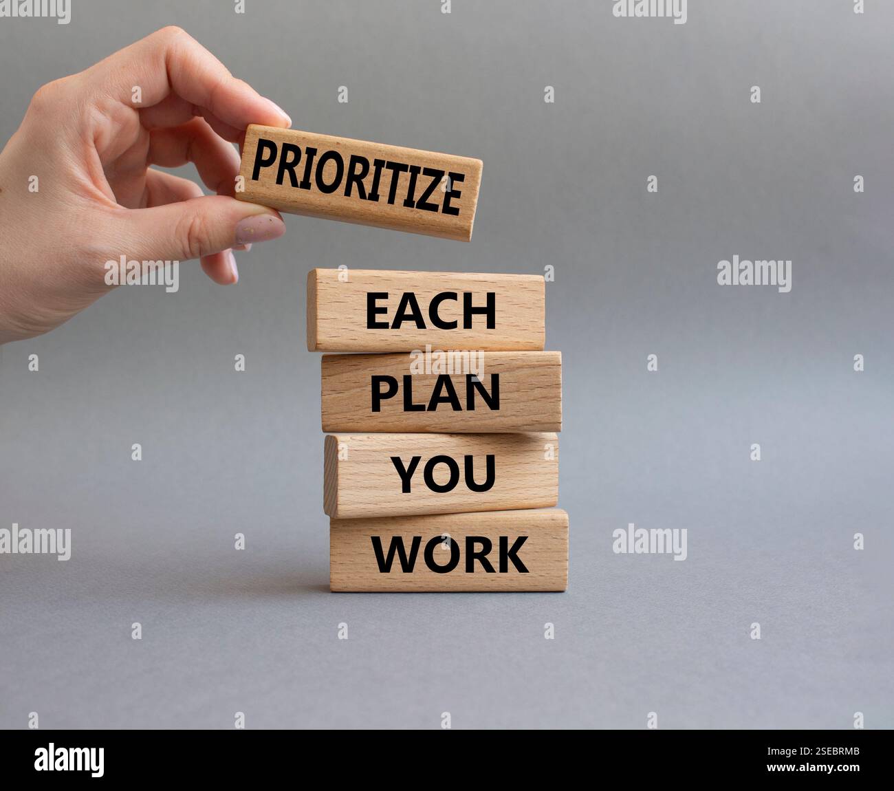 Priority, plan and work symbol. Wooden blocks with words Prioritize ...