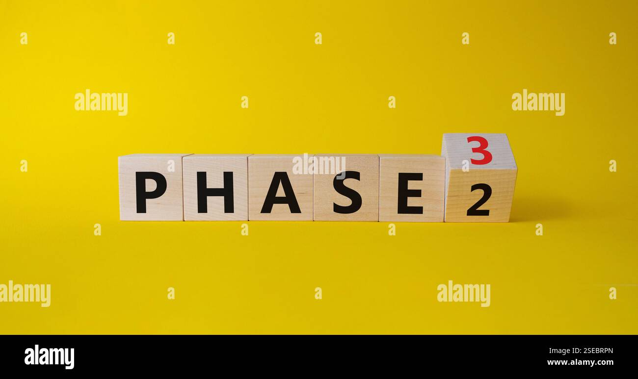 From Phase 2 to 3 symbol. Wooden cubes with words Phase 2 and Phase 3 ...