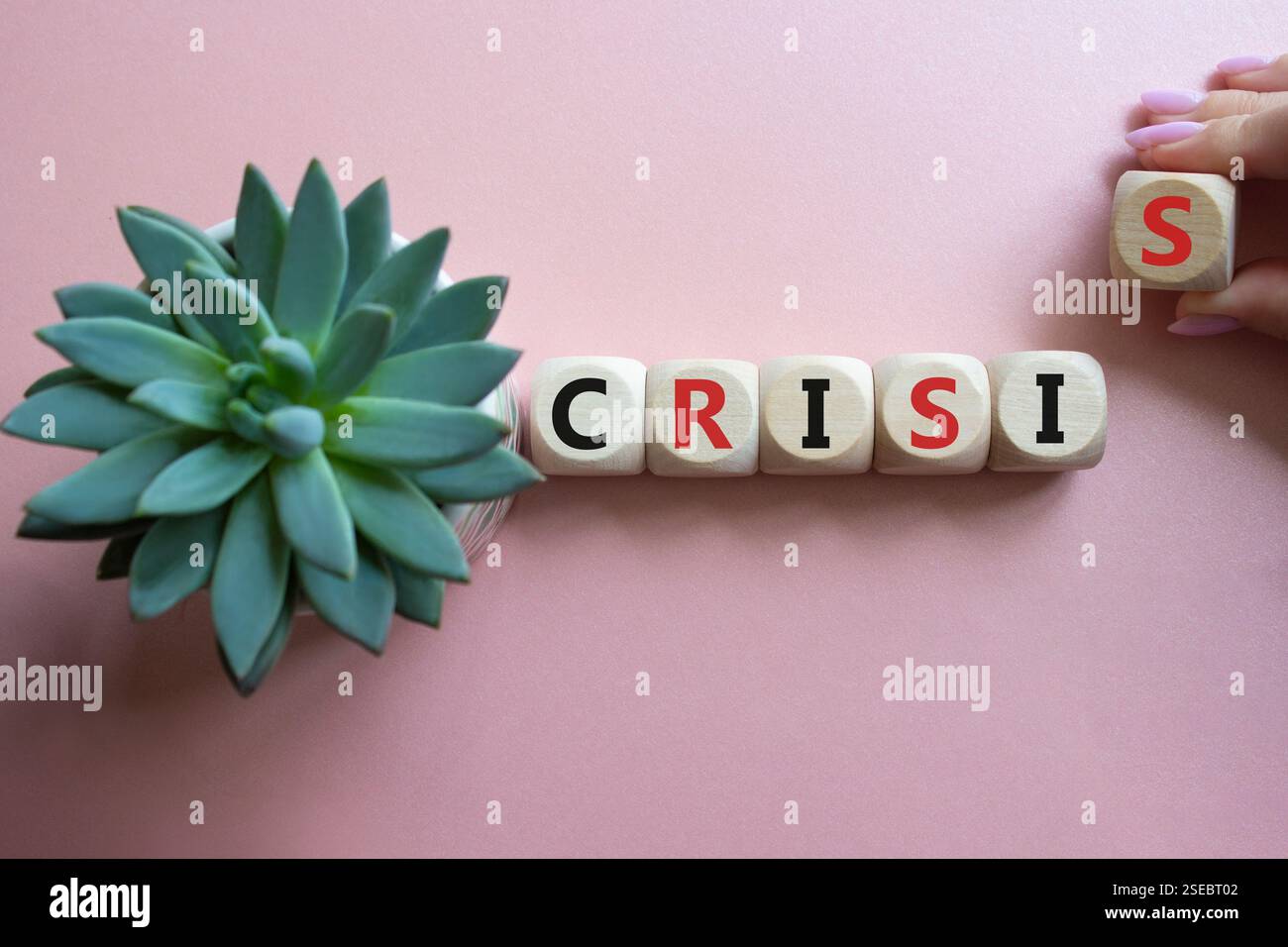 Crisis symbol. Concept word Crisis on wooden cubes. Businessman hand ...